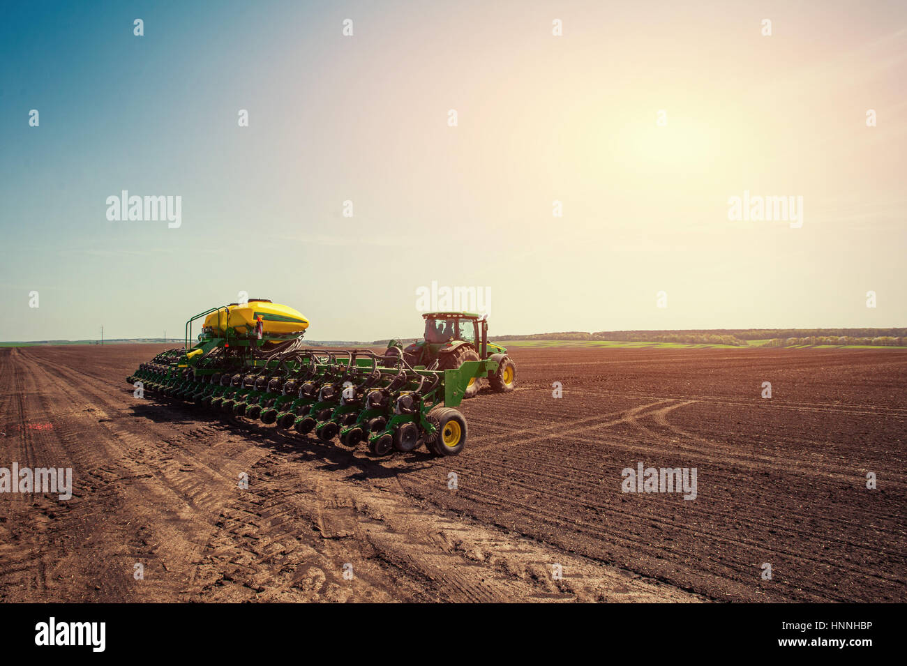Tractor plowing farm field in preparation for spring planting Stock ...