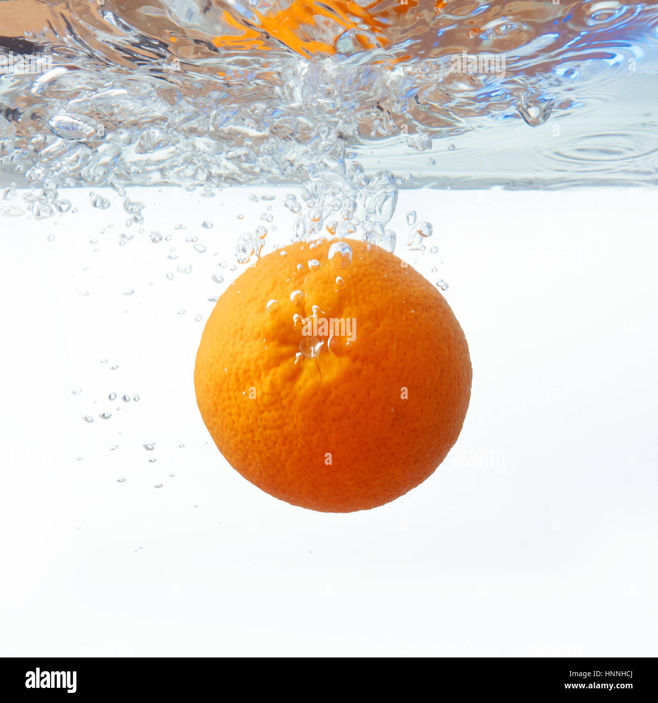 orange in spray of water with splash on white background Stock Photo ...