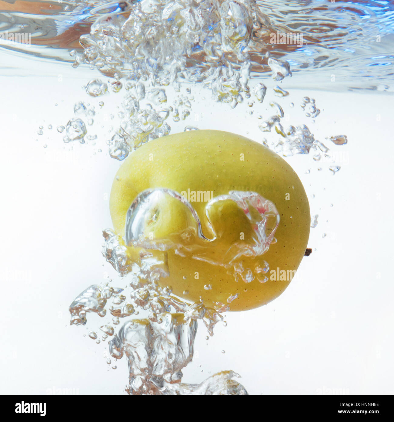 Green apple under water with a trail of transparent bubbles Stock Photo ...