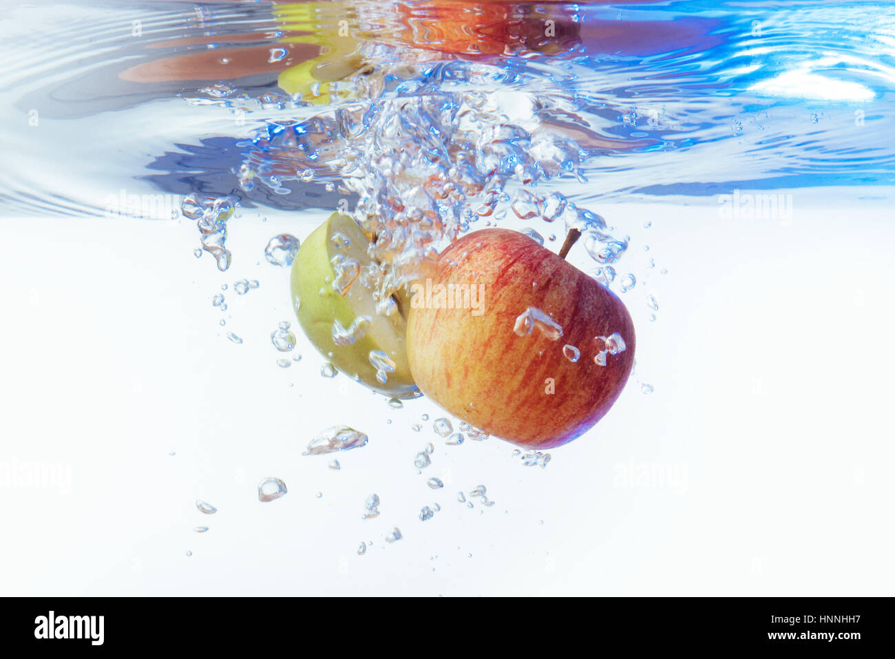apple in water on a white background Stock Photo - Alamy