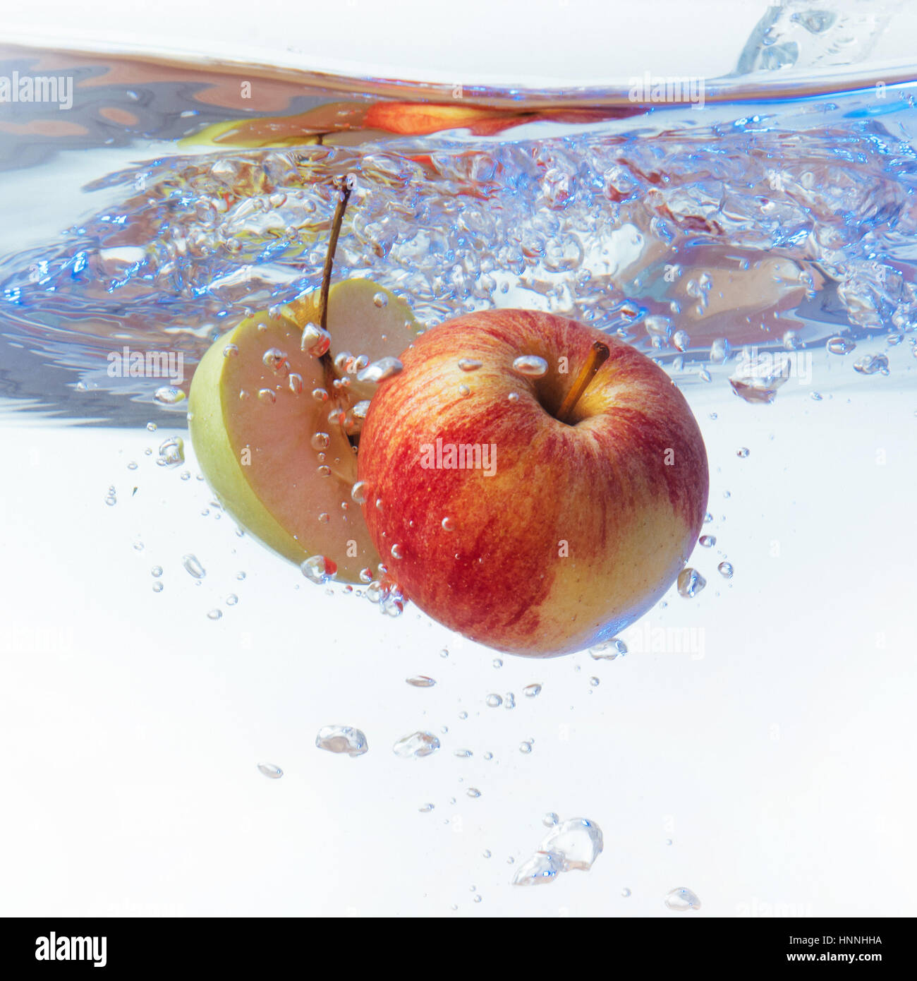 apple in water on a white background Stock Photo - Alamy