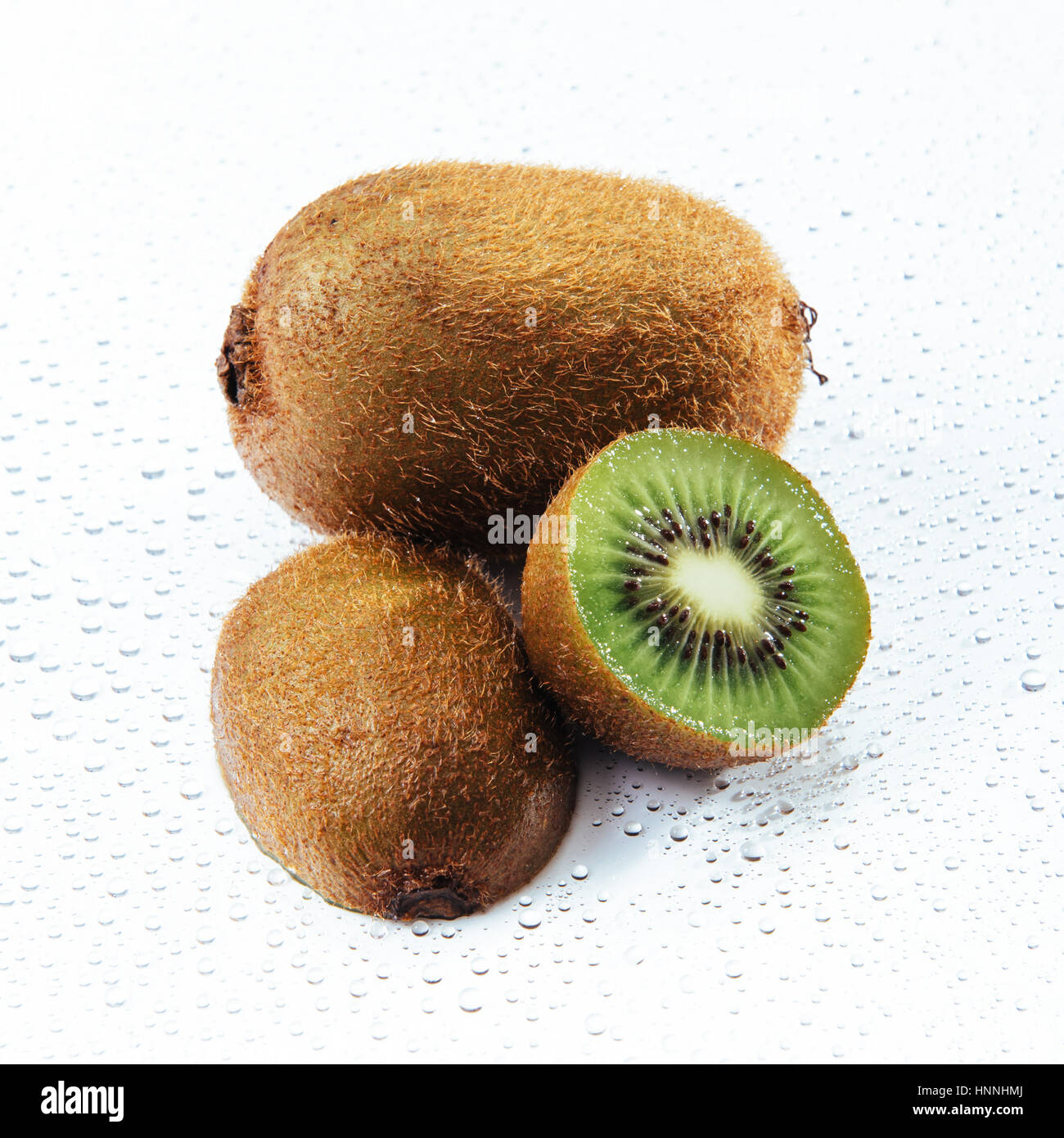 Whole kiwi fruit and his sliced segments isolated Stock Photo - Alamy
