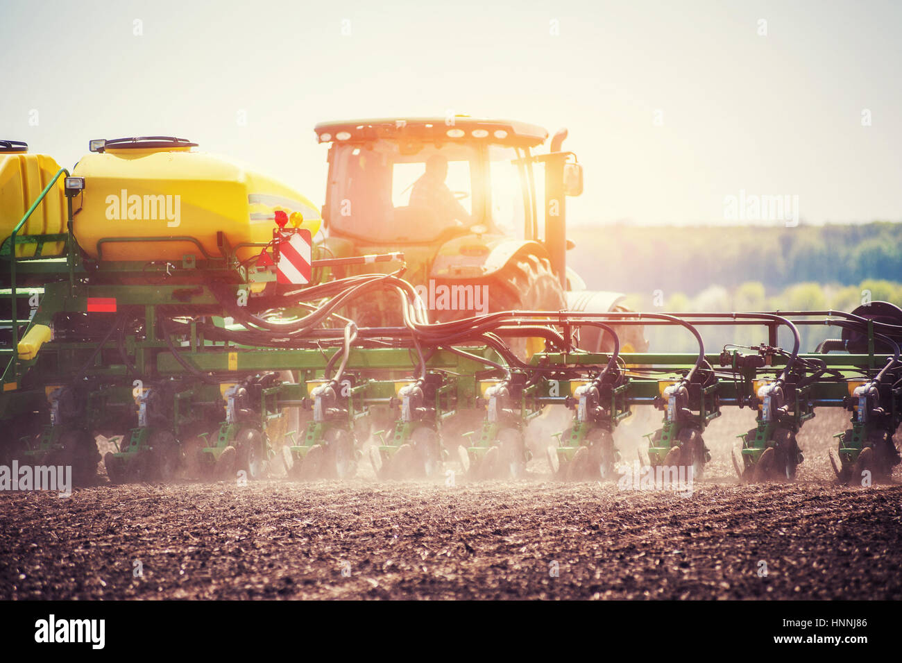Tractor plowing farm field in preparation for spring planting Stock ...