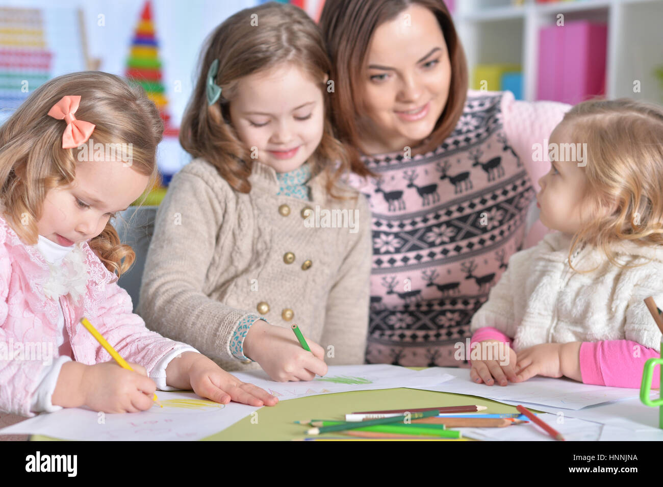 Mother and her three daughters drawing Stock Photo - Alamy