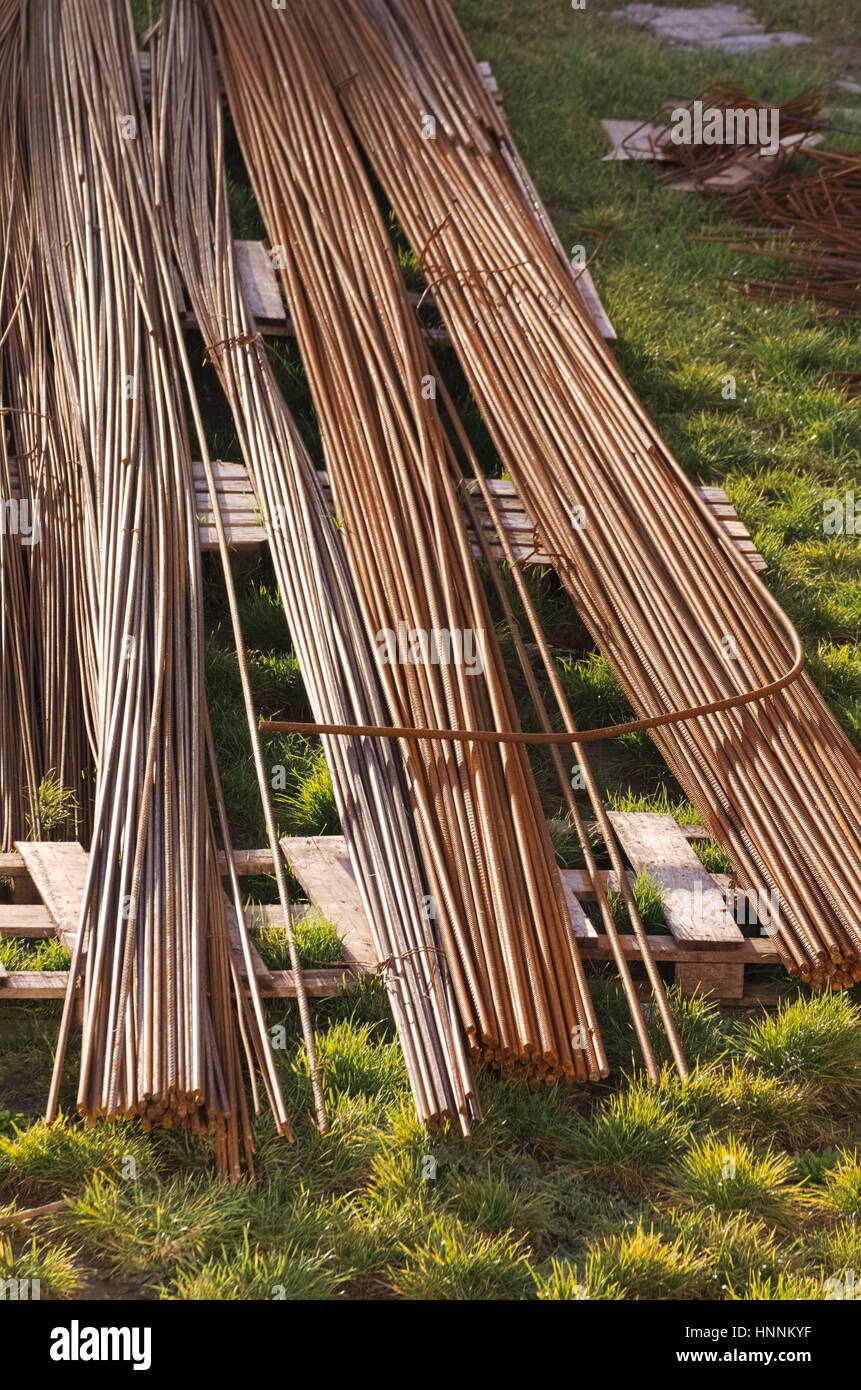 Rusty Construction Rods on the Green Grass Vertical Stock Photo - Alamy