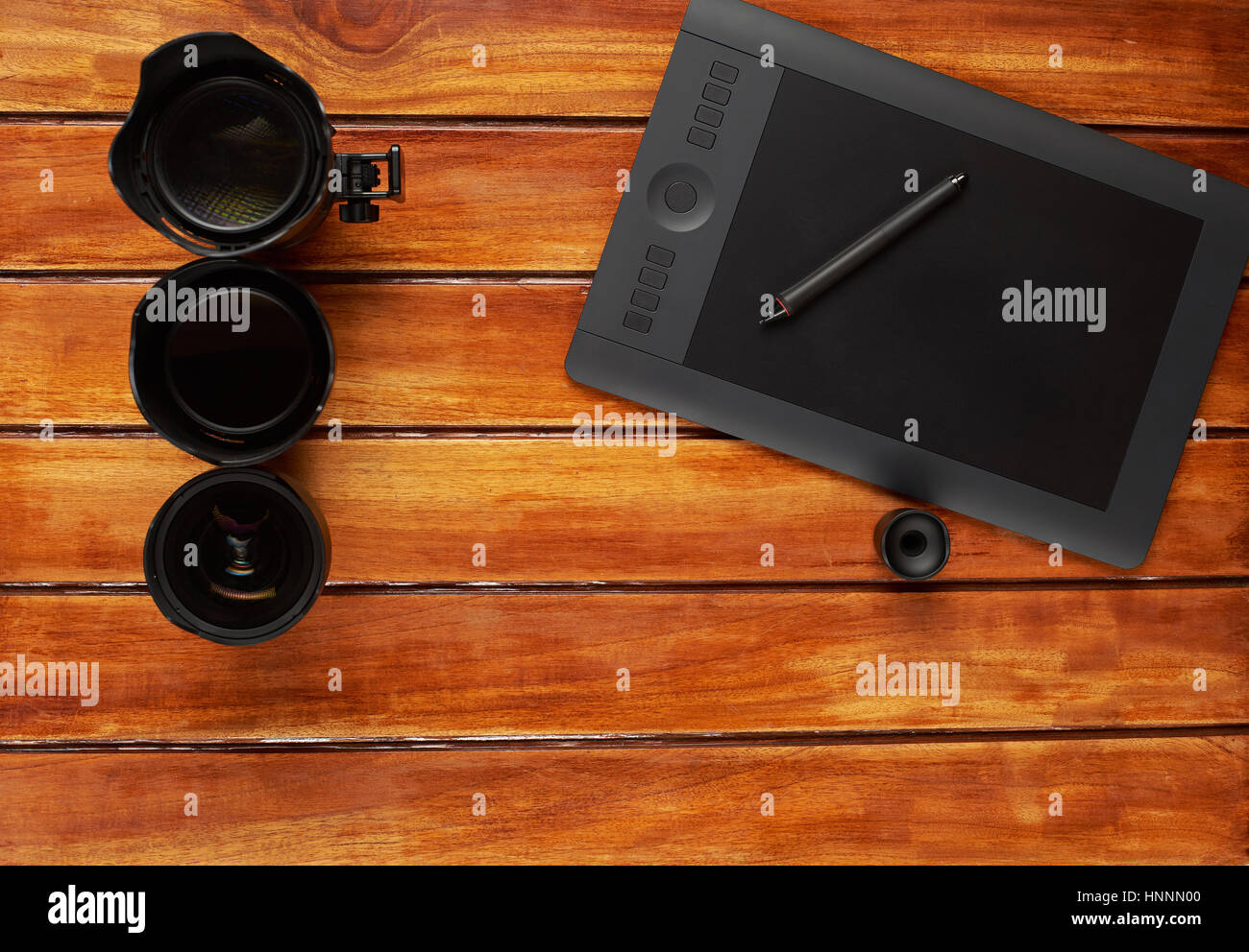 Photography dlsr lens on wood table with graphic designer tablet Stock ...