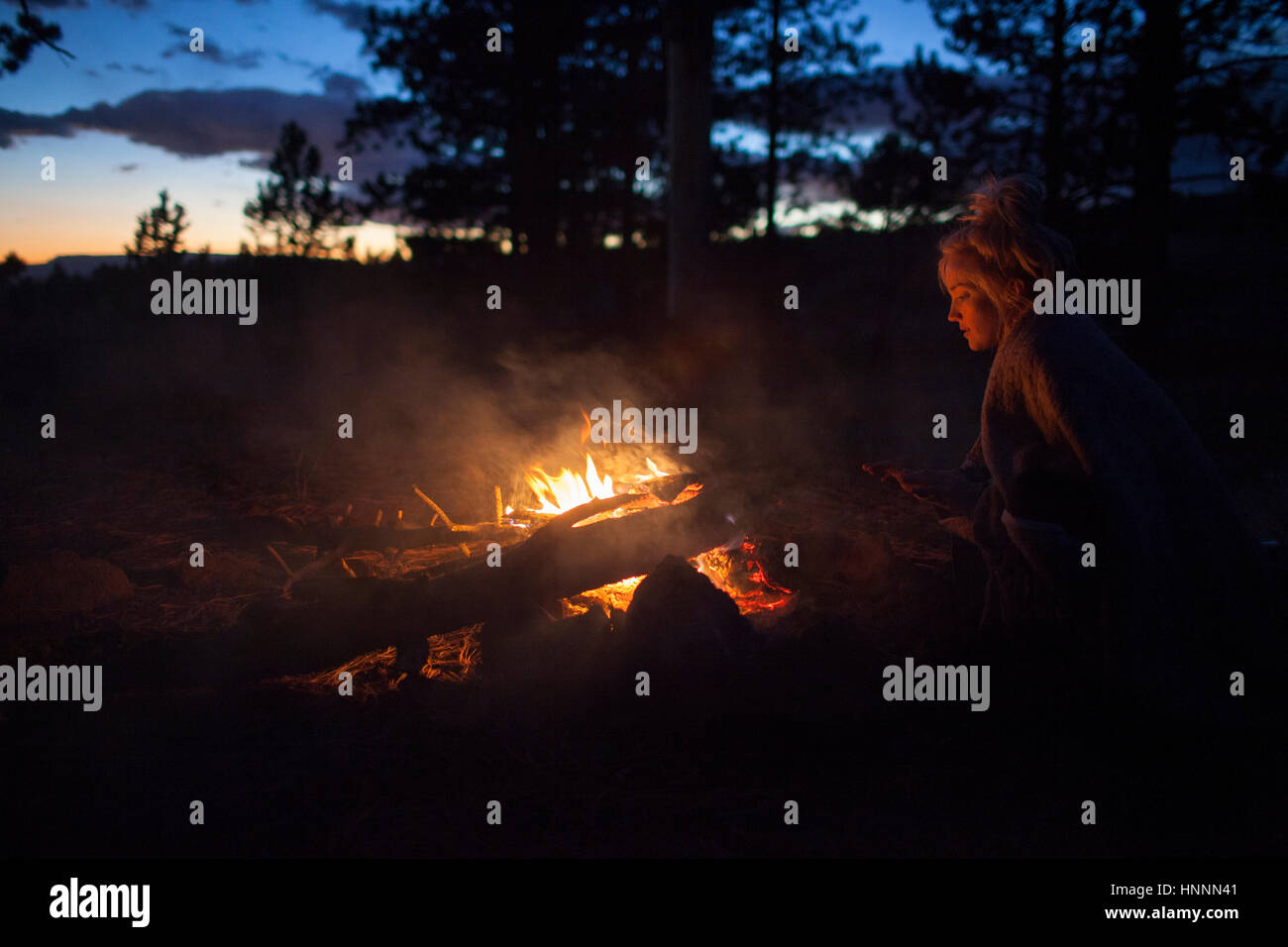 Woman sitting fire night hi-res stock photography and images - Alamy