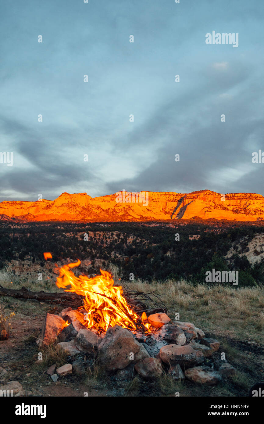 View of bonfire on field against mountains Stock Photo - Alamy