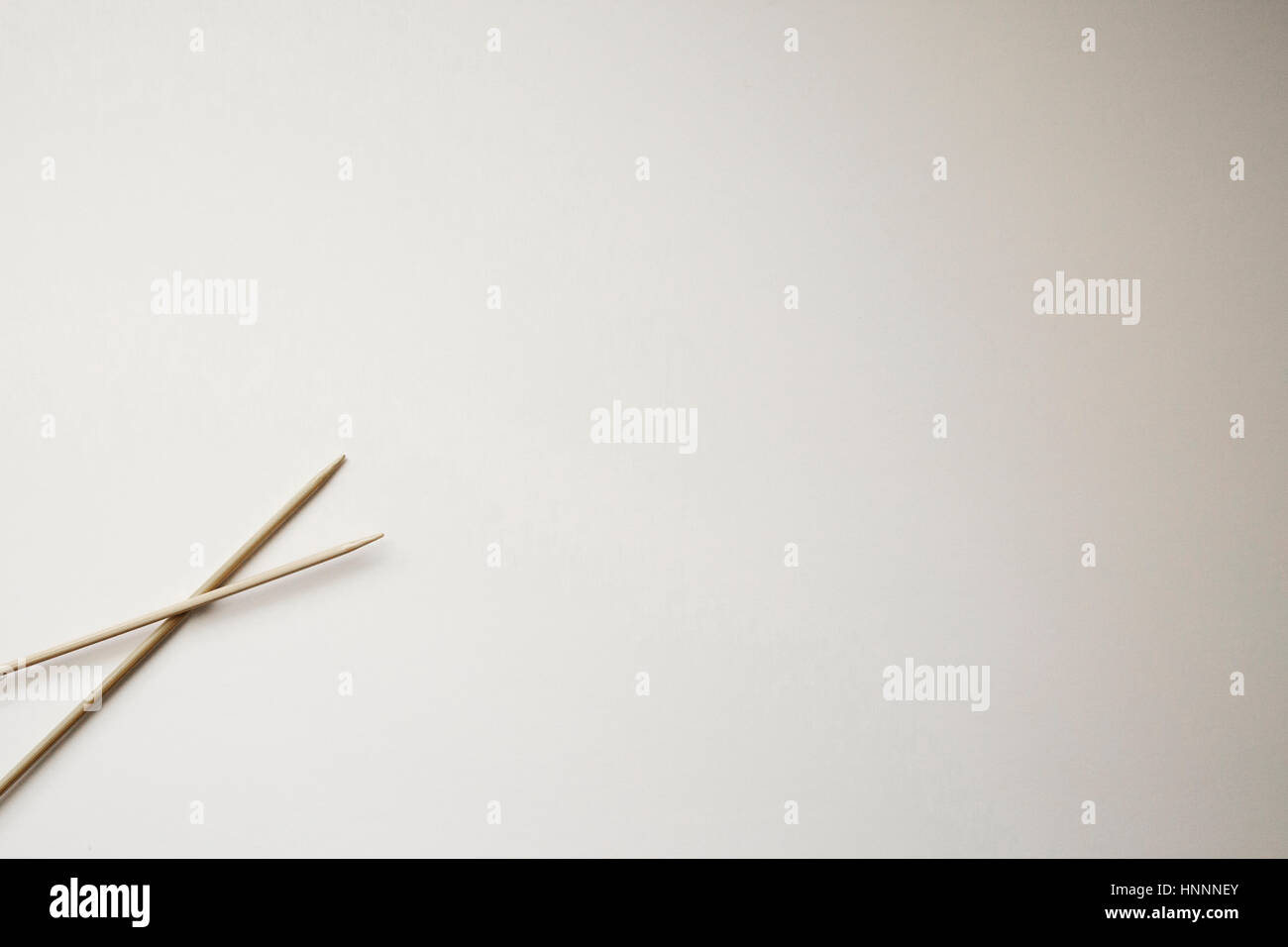 Chopsticks against white background Stock Photo - Alamy
