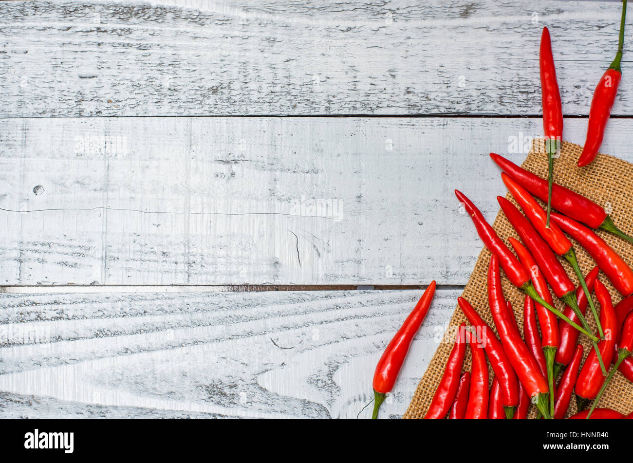 Hot and spicy red chilli on wood table background Stock Photo - Alamy
