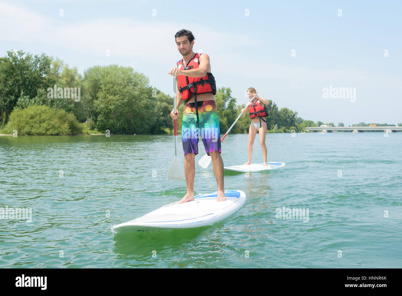 silhouette of perfect couple engage standup paddle boarding Stock Photo ...
