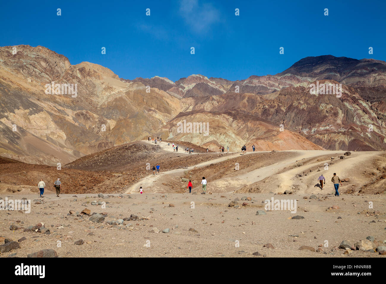 Tourists hiking on a trail in the Death Valley National Park ...