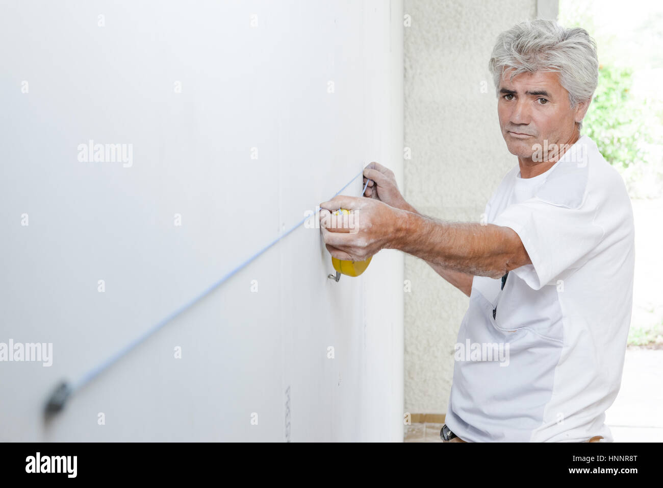 Measuring a wall Stock Photo - Alamy