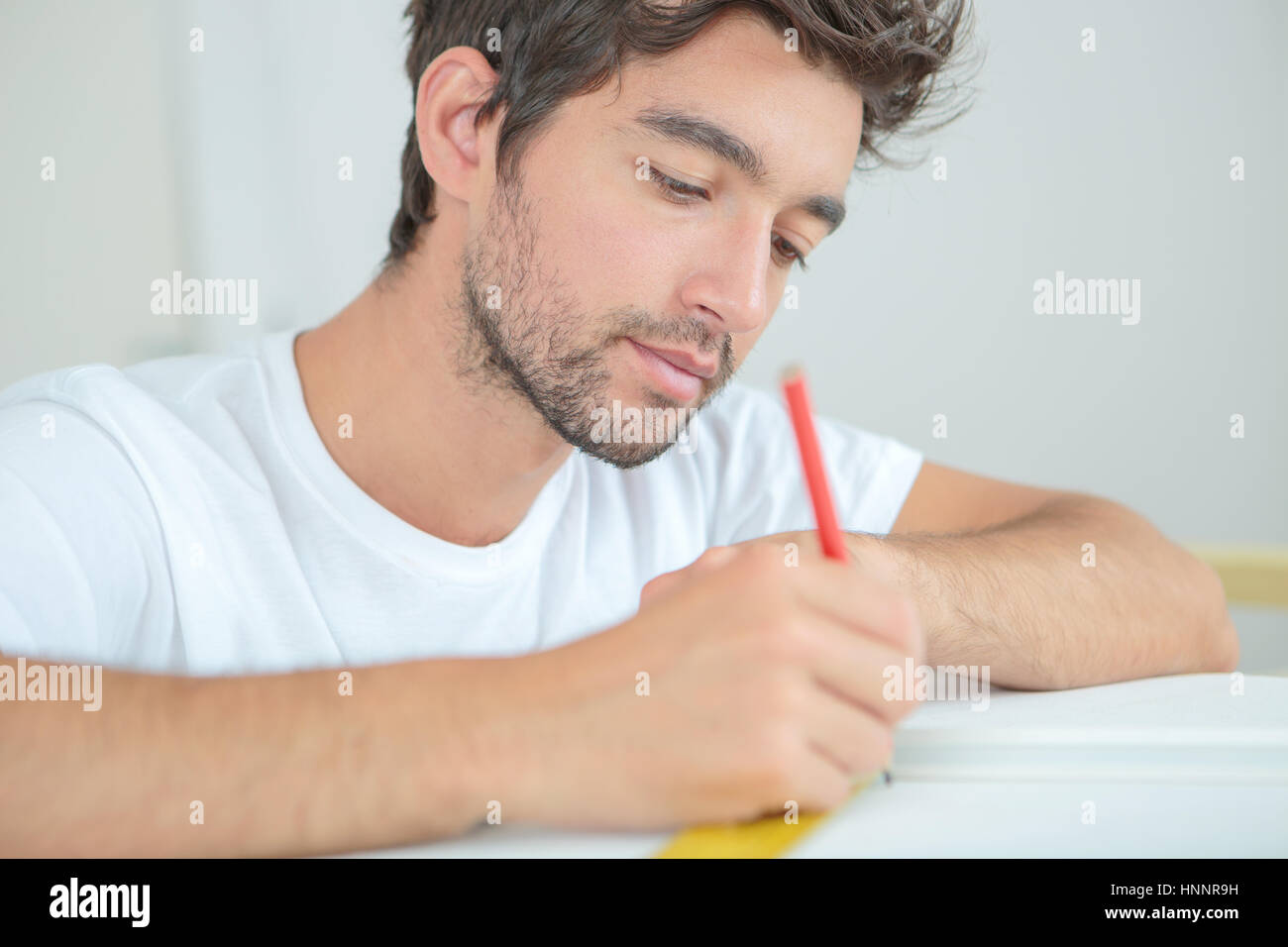 Man at desk with ruler and pencil Stock Photo - Alamy