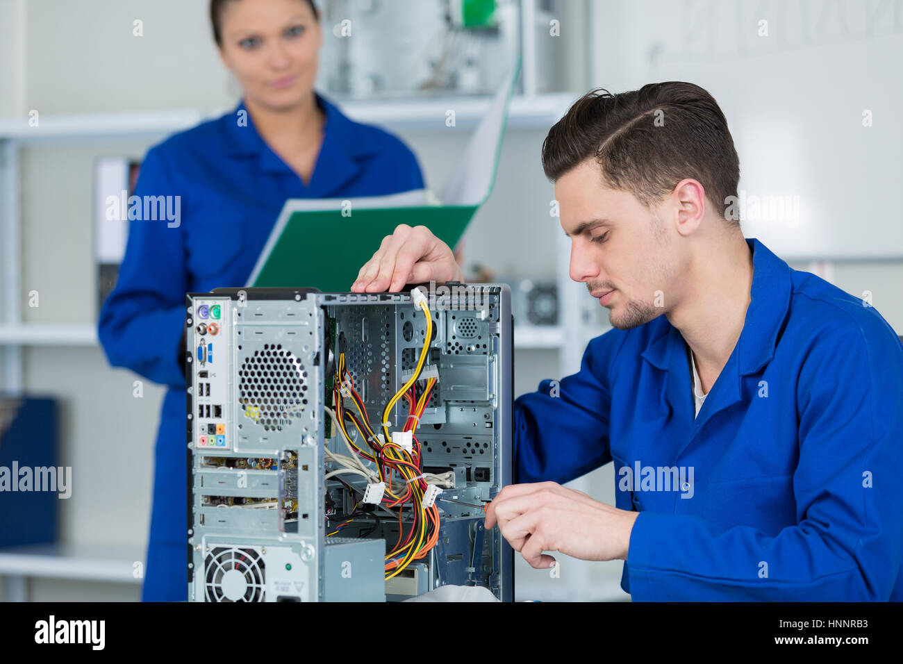 team of students examining and repairing computer parts Stock Photo - Alamy