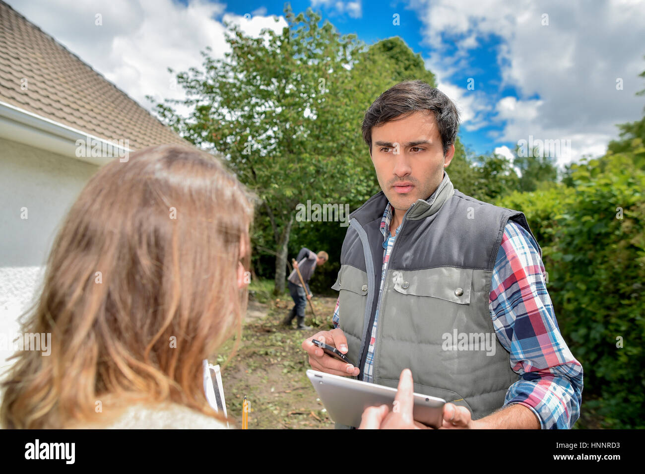 Foreman explaining to a client Stock Photo - Alamy