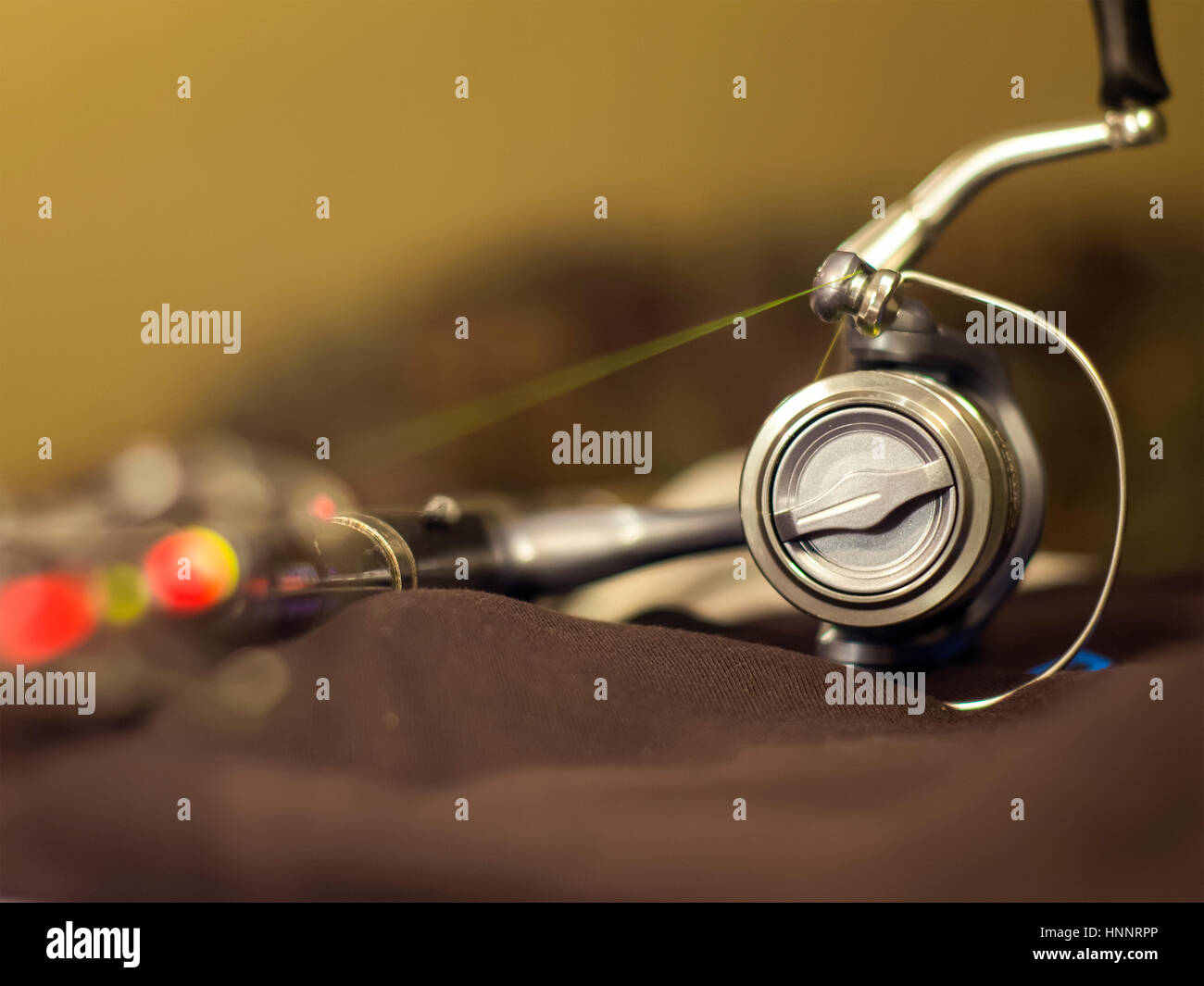 The reliable and high-quality silver fishing reel Stock Photo - Alamy