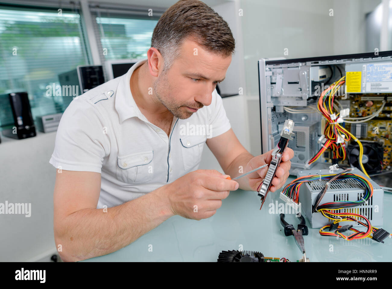 Man working on computer component Stock Photo - Alamy