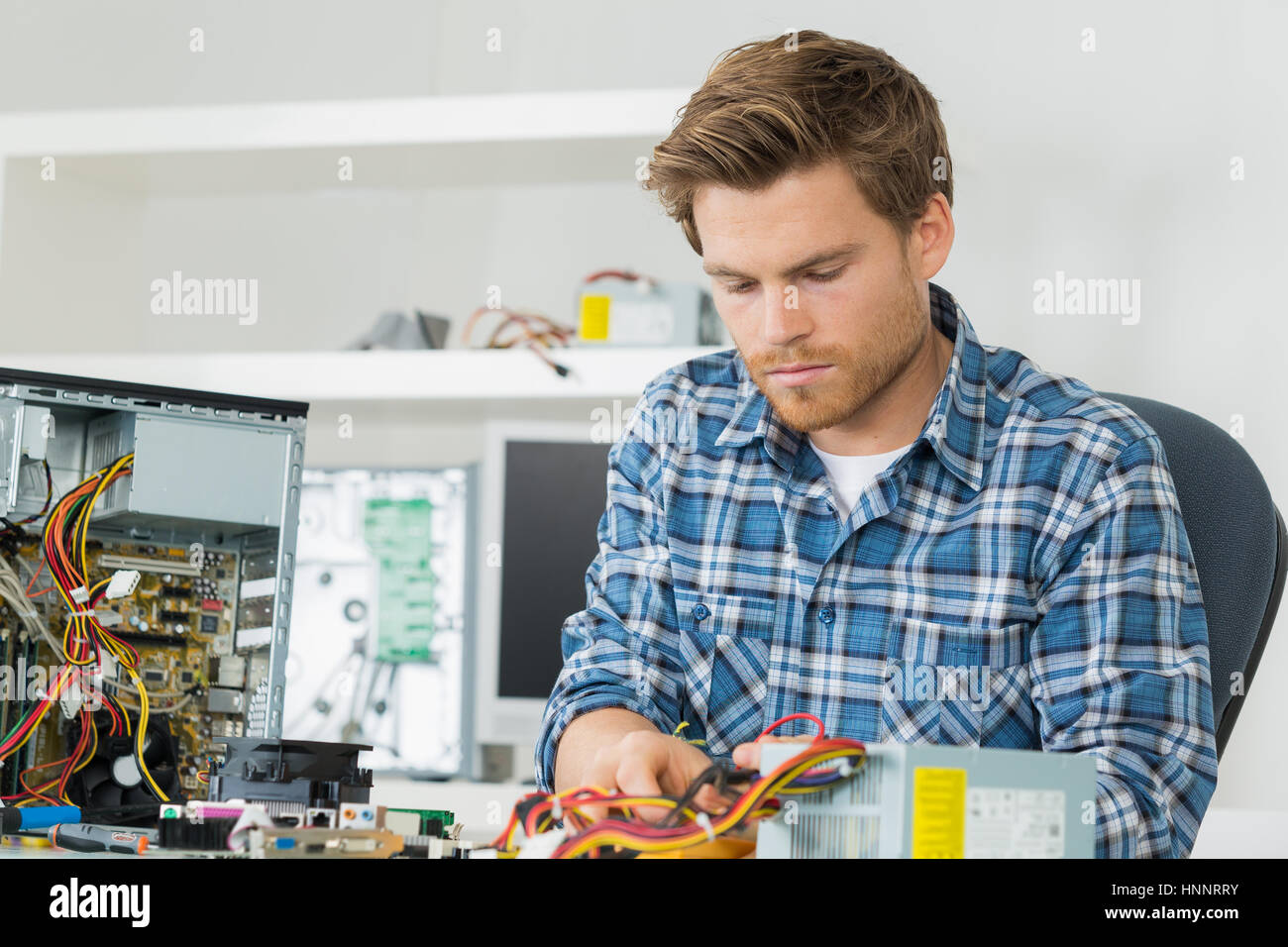 handsome computer engineer repairing a faulty pc Stock Photo - Alamy