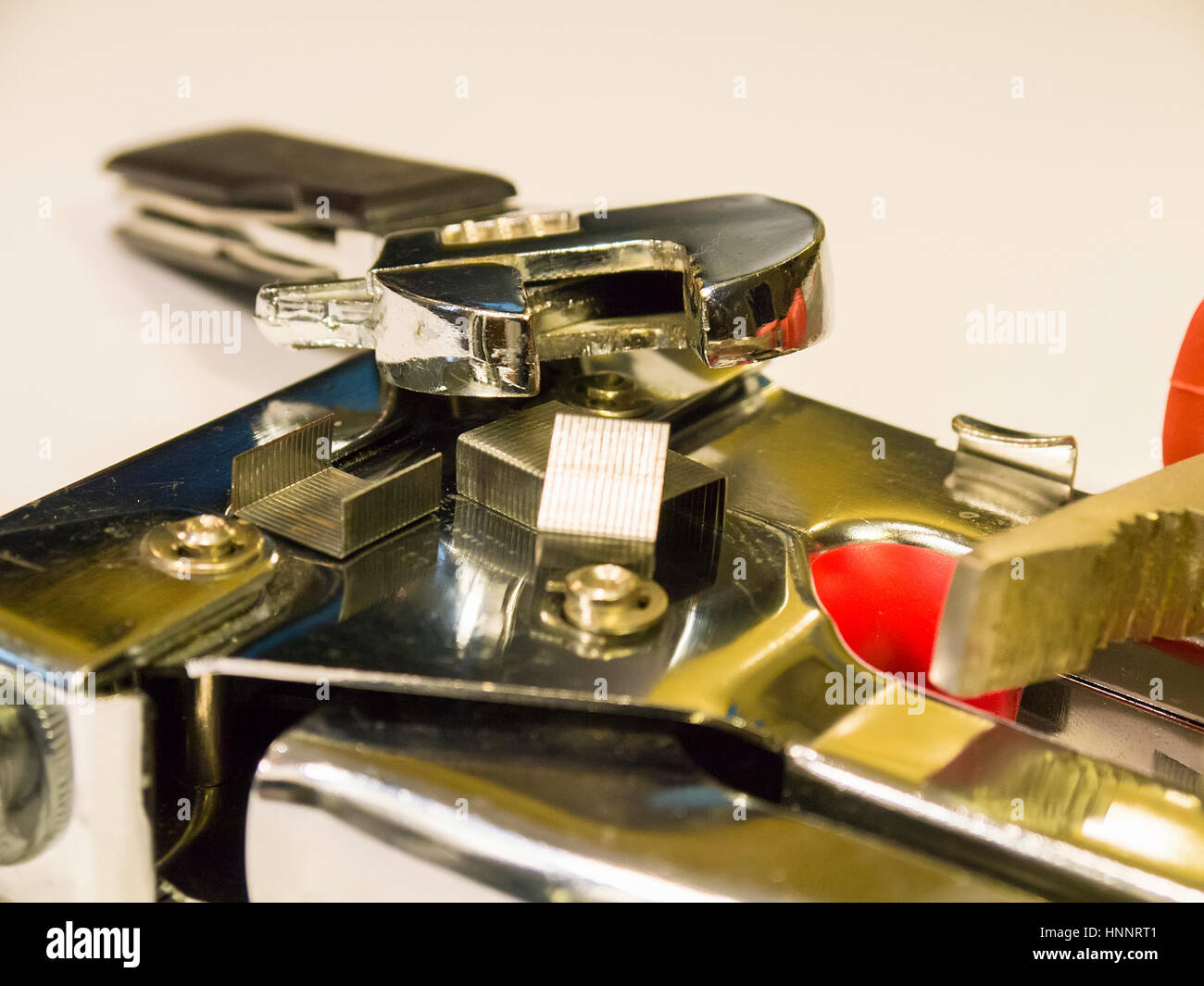 The stapler, pliers and a wrench on a white background Stock Photo - Alamy
