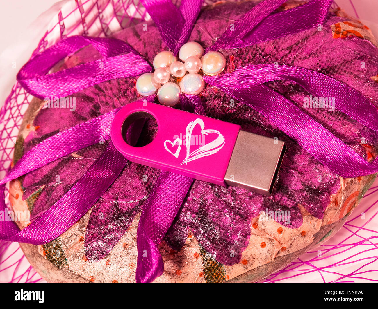 Pink USB flash drive with hearts on the beautiful figure closeup Stock ...