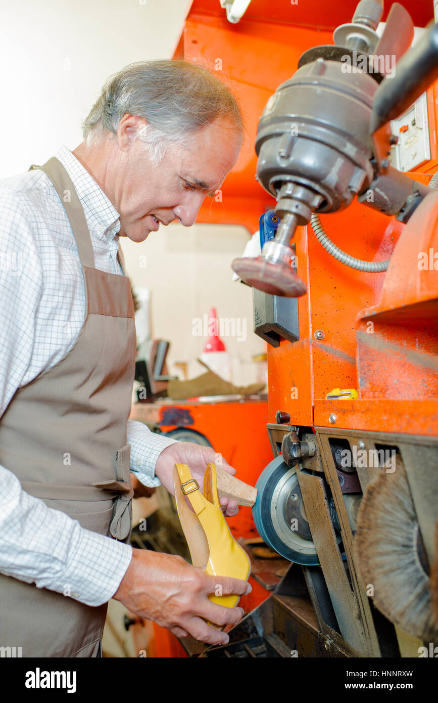 Cobbler repairing a heel Stock Photo - Alamy