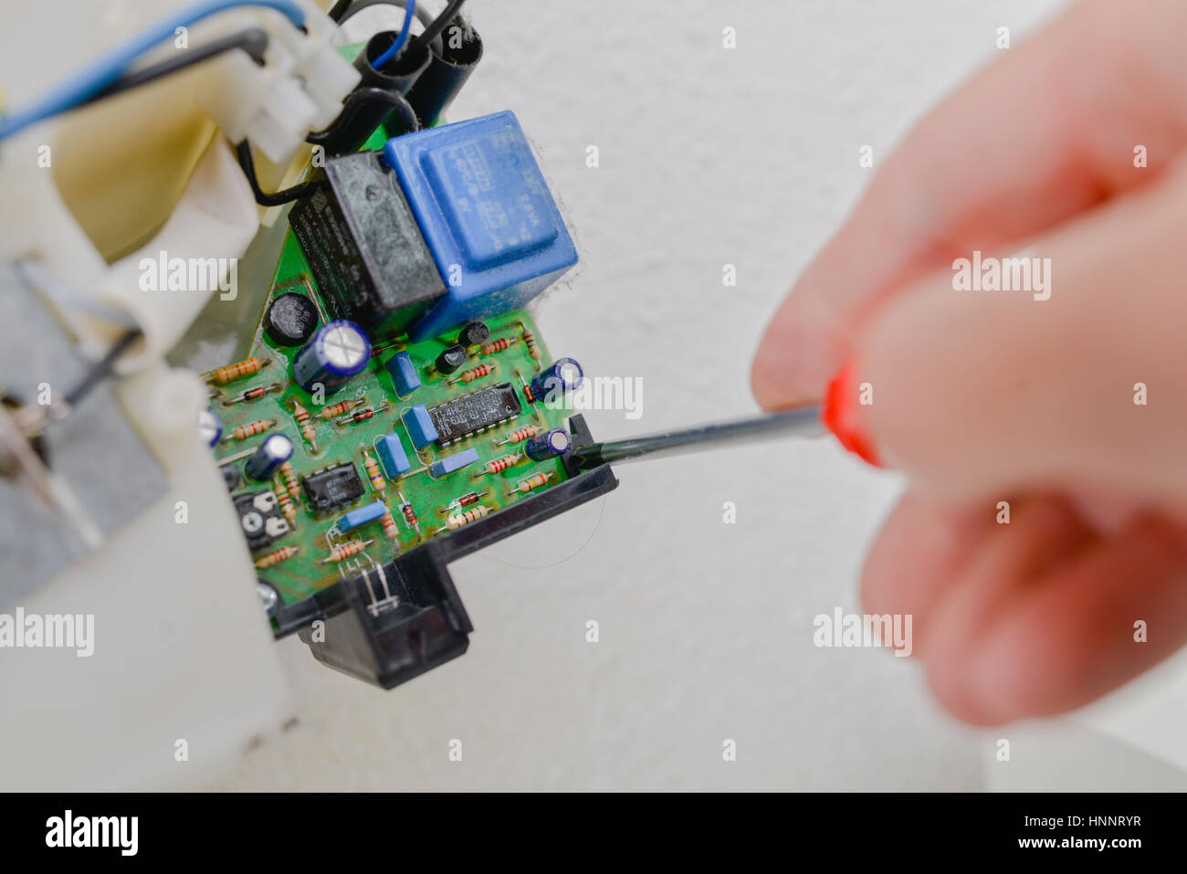 Closeup of screwdriver in circuit board Stock Photo - Alamy