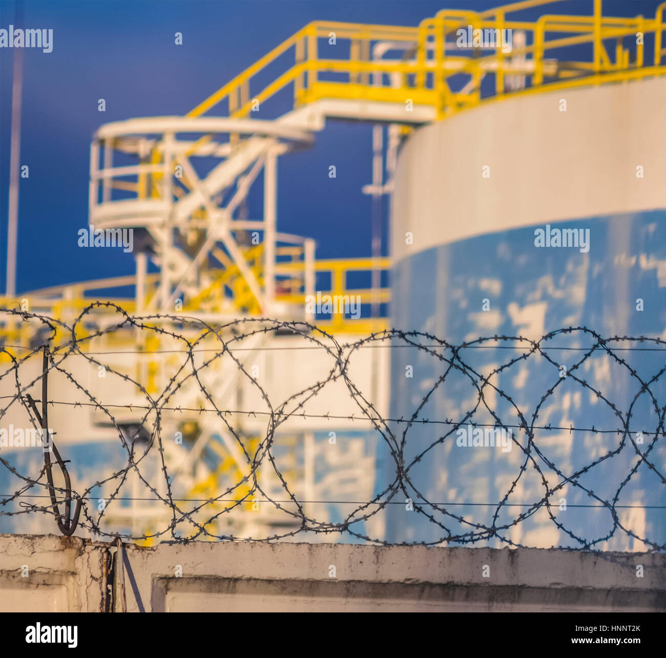 The barbed wire on a fence near tanks Stock Photo - Alamy