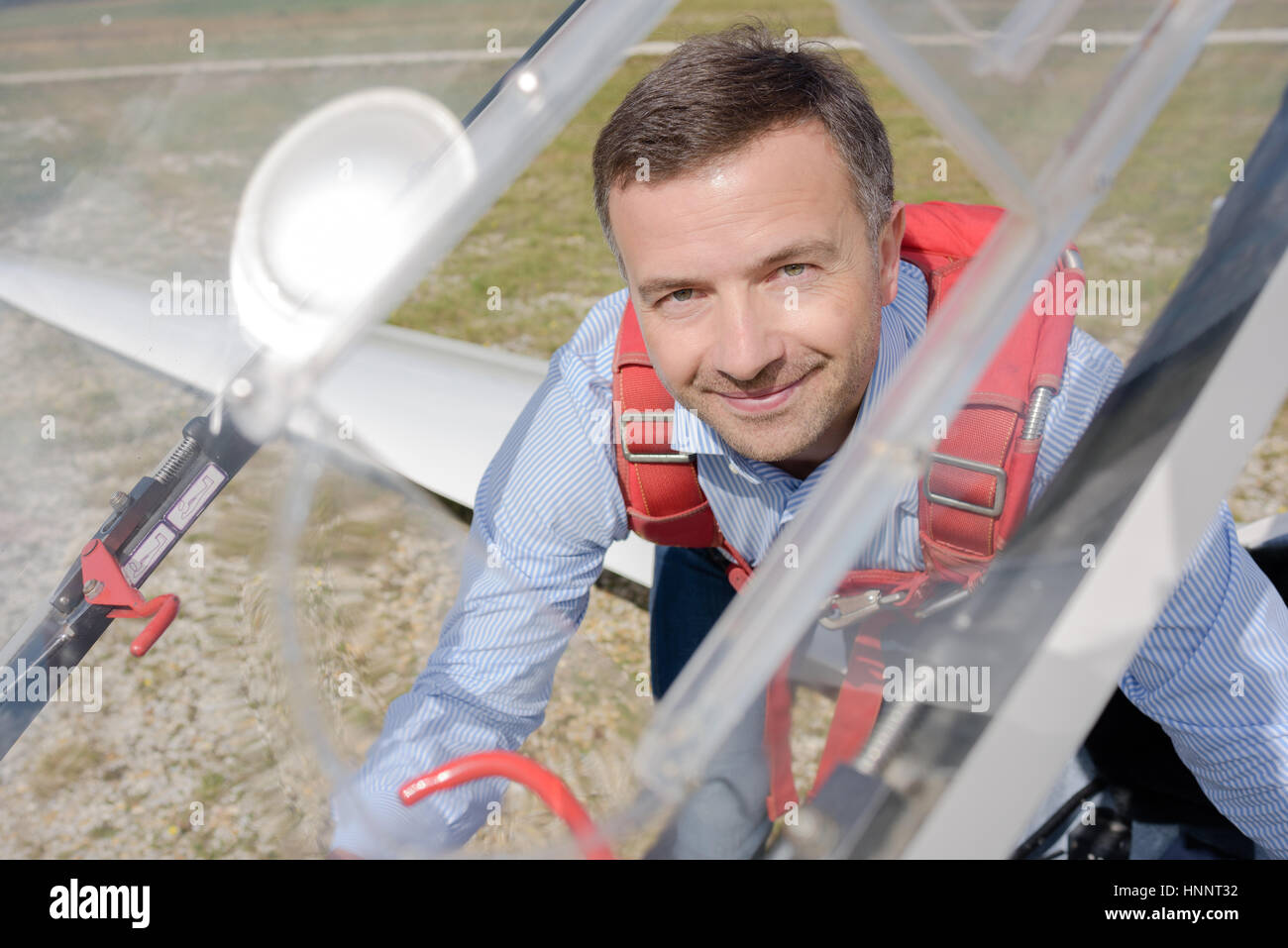 Man climbing into glider Stock Photo - Alamy