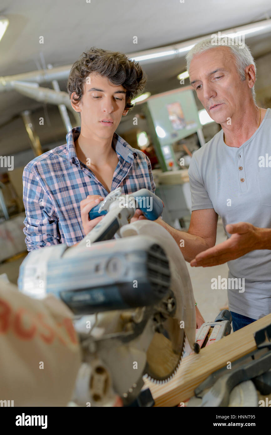 Carpenters using a band saw Stock Photo - Alamy