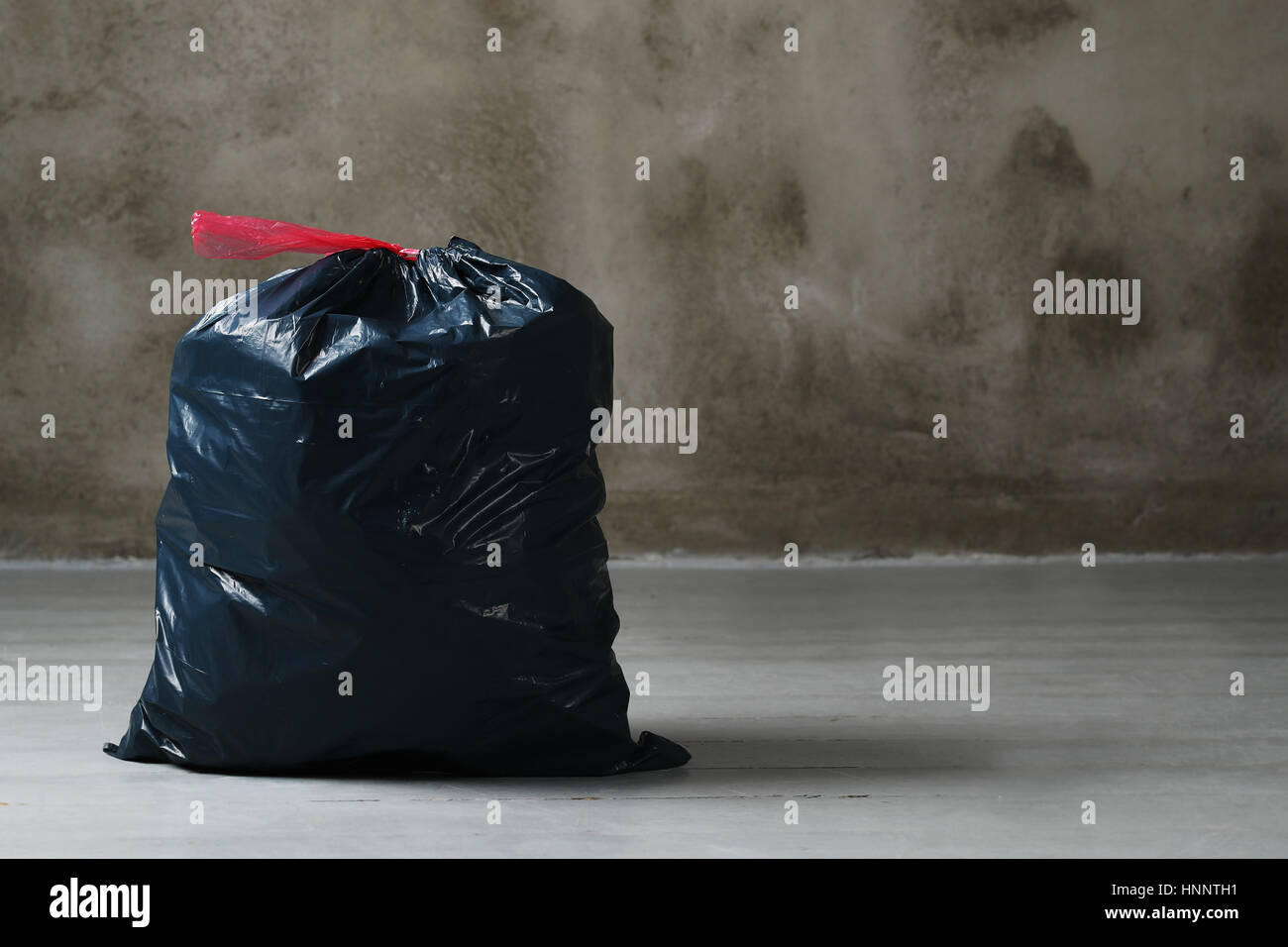 Pollution. Trash bag on the floor Stock Photo - Alamy