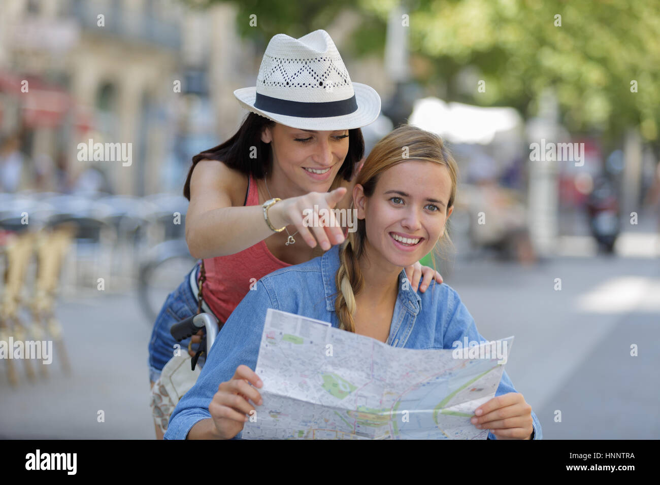 Two girls one wheelchair hi-res stock photography and images - Alamy