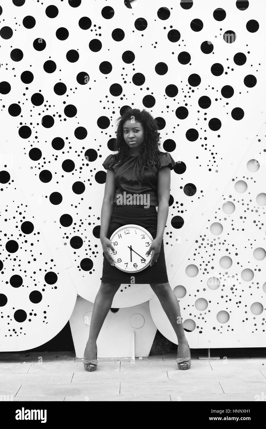 woman holding clock Stock Photo - Alamy