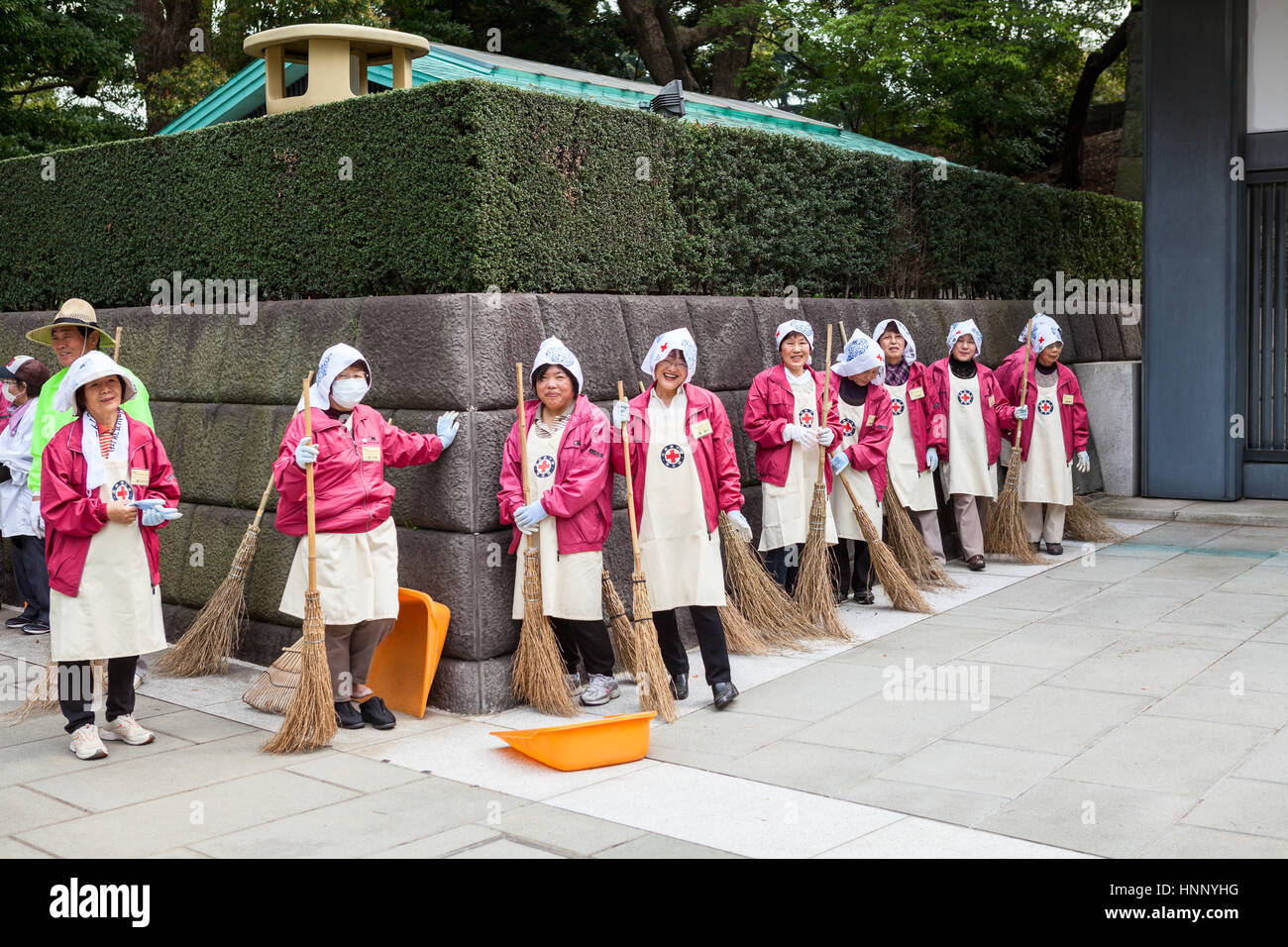 TOKYO, JAPAN - CIRCA APR, 2013: Cleaning female workers with brooms in ...