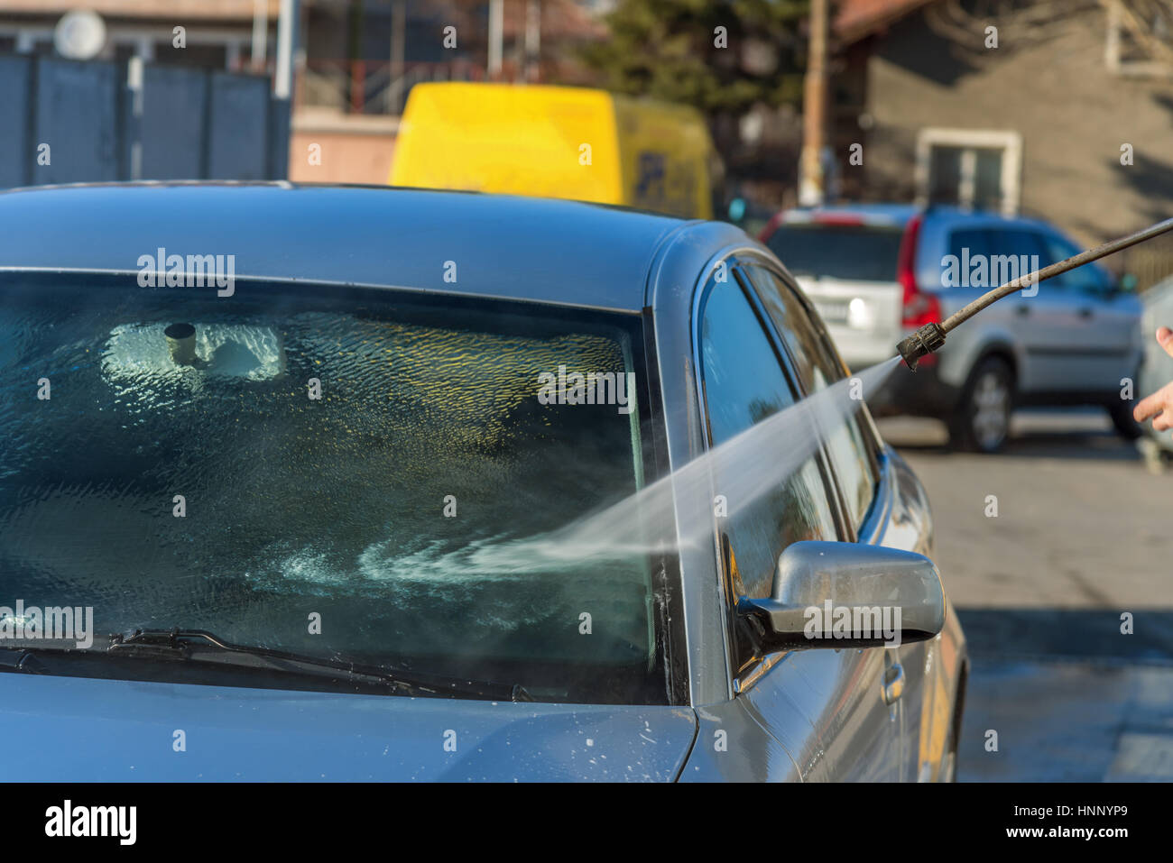 Car washing with flowing water. Outdoor Self Service Cleaning Car Using ...