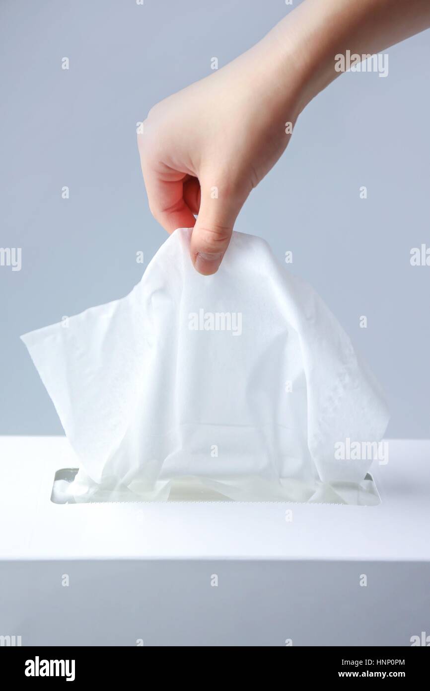 A hand seizing tissue Stock Photo - Alamy