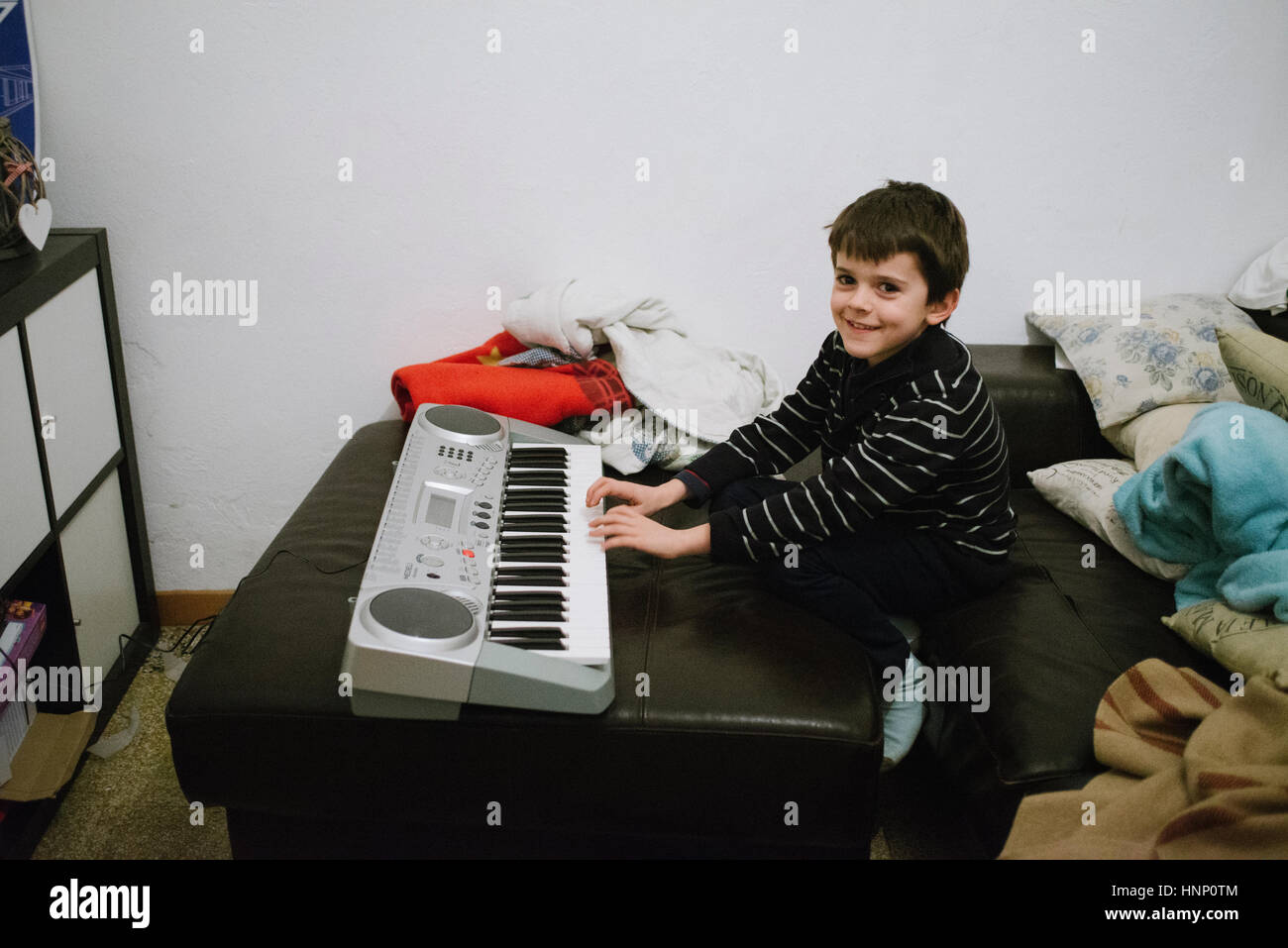 child plays electronic keyboard at home Stock Photo - Alamy