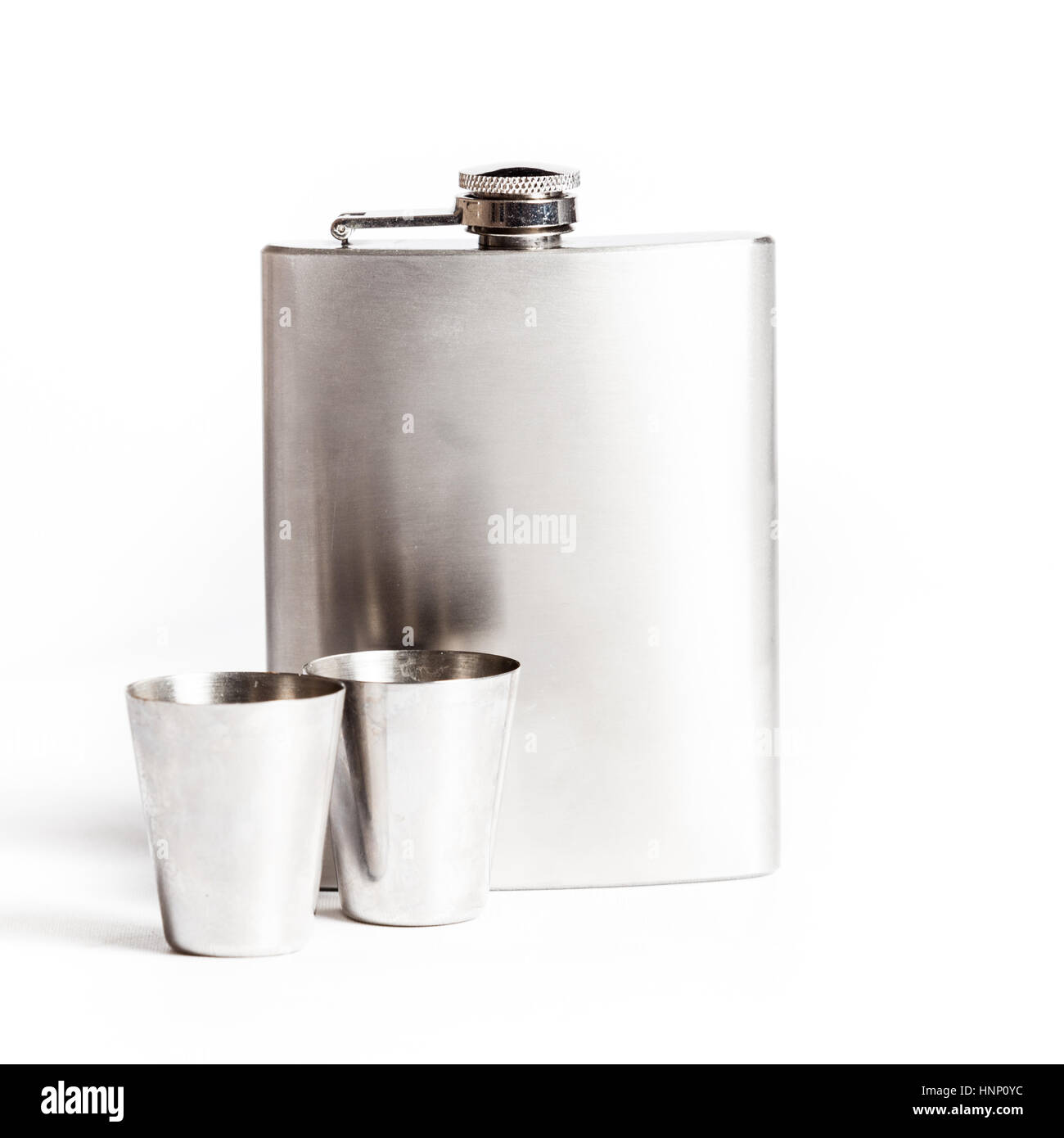 Hip flask and cups isolated on white Stock Photo - Alamy
