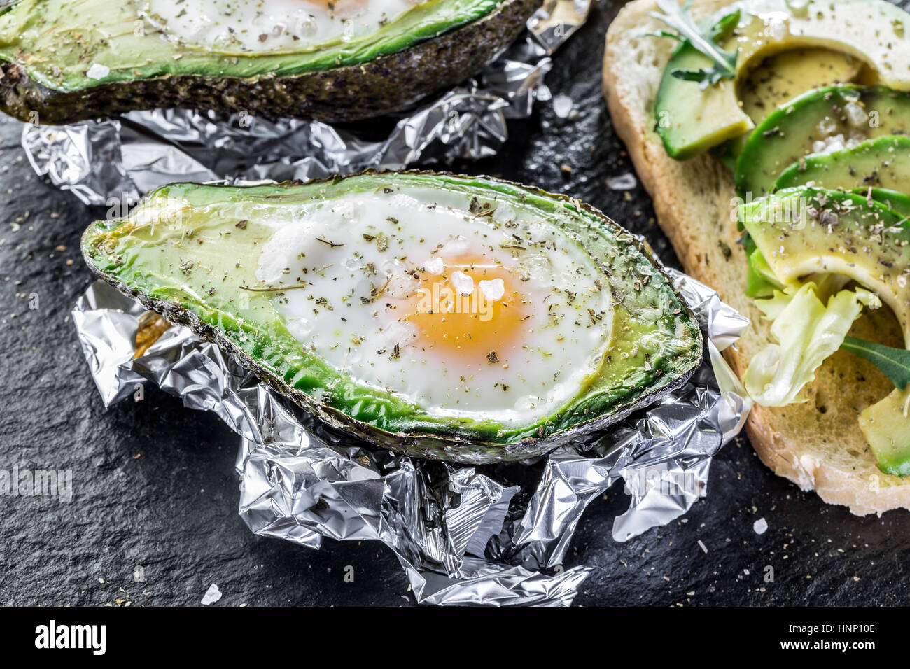 Chicken egg baked in avocado. Delicious meal Stock Photo - Alamy