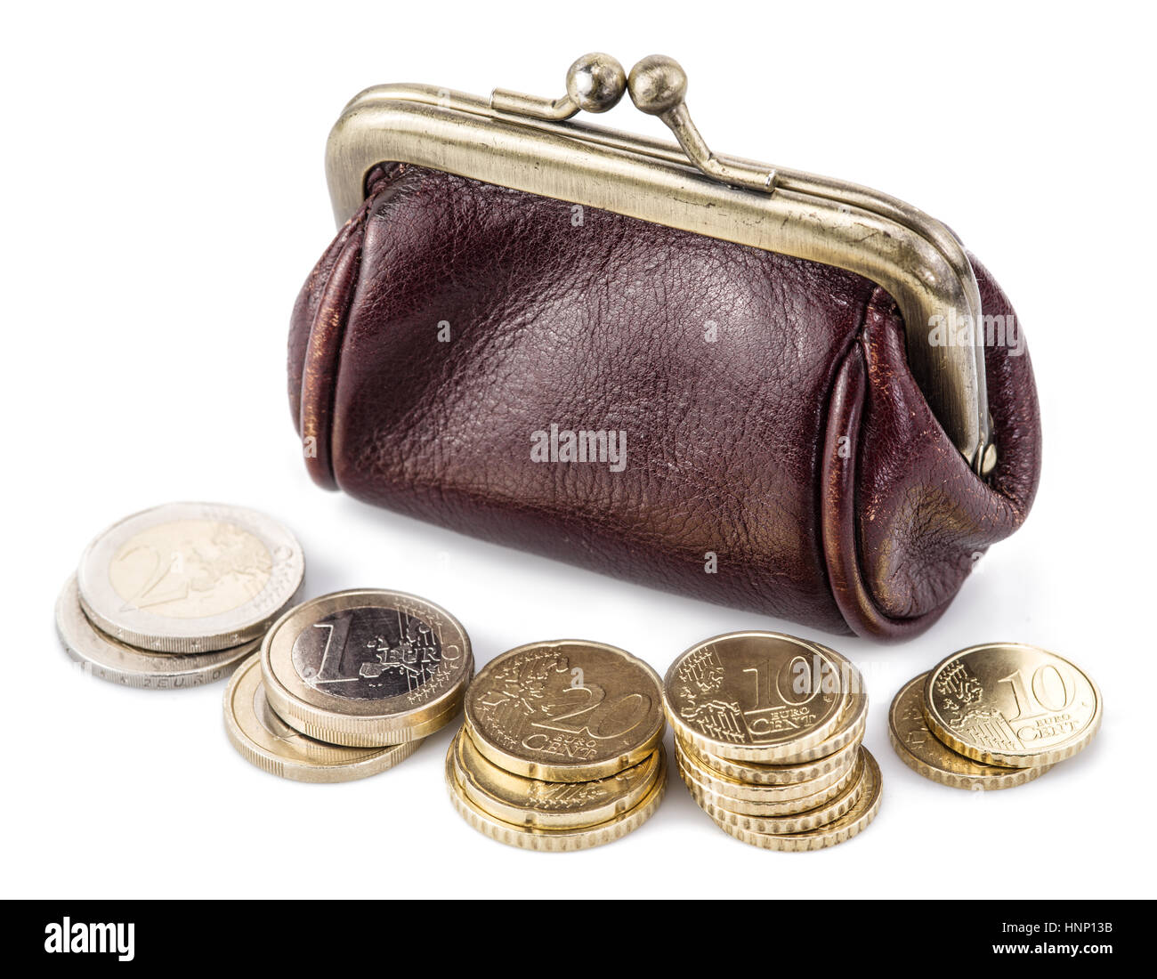 Small leather purse for coins and coins near it. Isolated on white ...