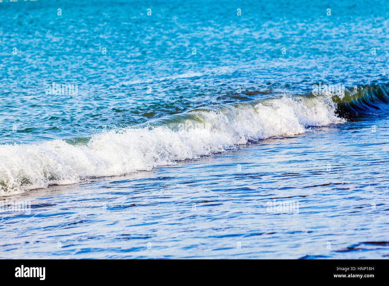 wave breaking along the beach Stock Photo - Alamy