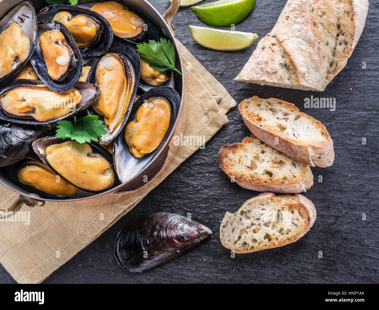 Boiled mussels in copper pan on the graphite background Stock Photo - Alamy