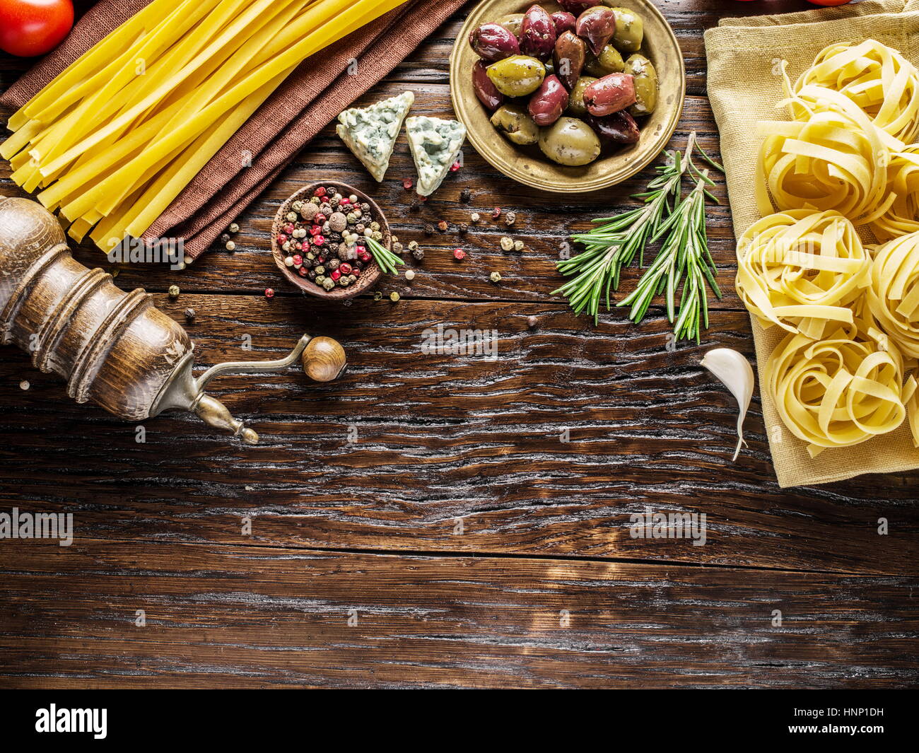 Pasta ingredients. Cherry-tomatoes, spaghetti pasta, rosemary and ...