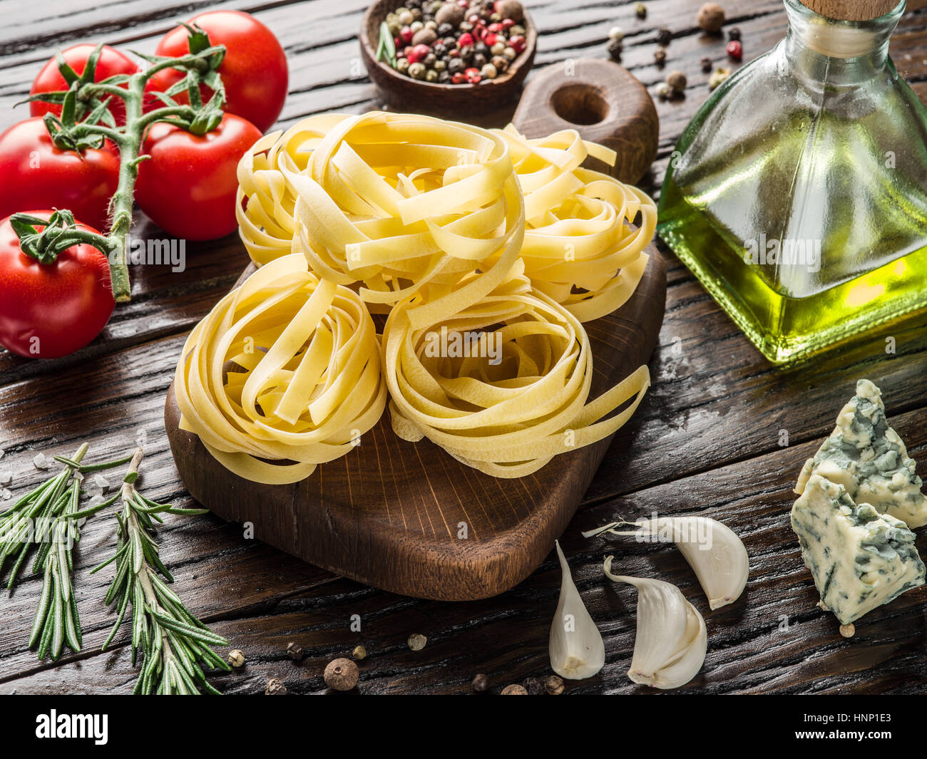 Pasta ingredients. Cherry-tomatoes, spaghetti pasta, rosemary and ...
