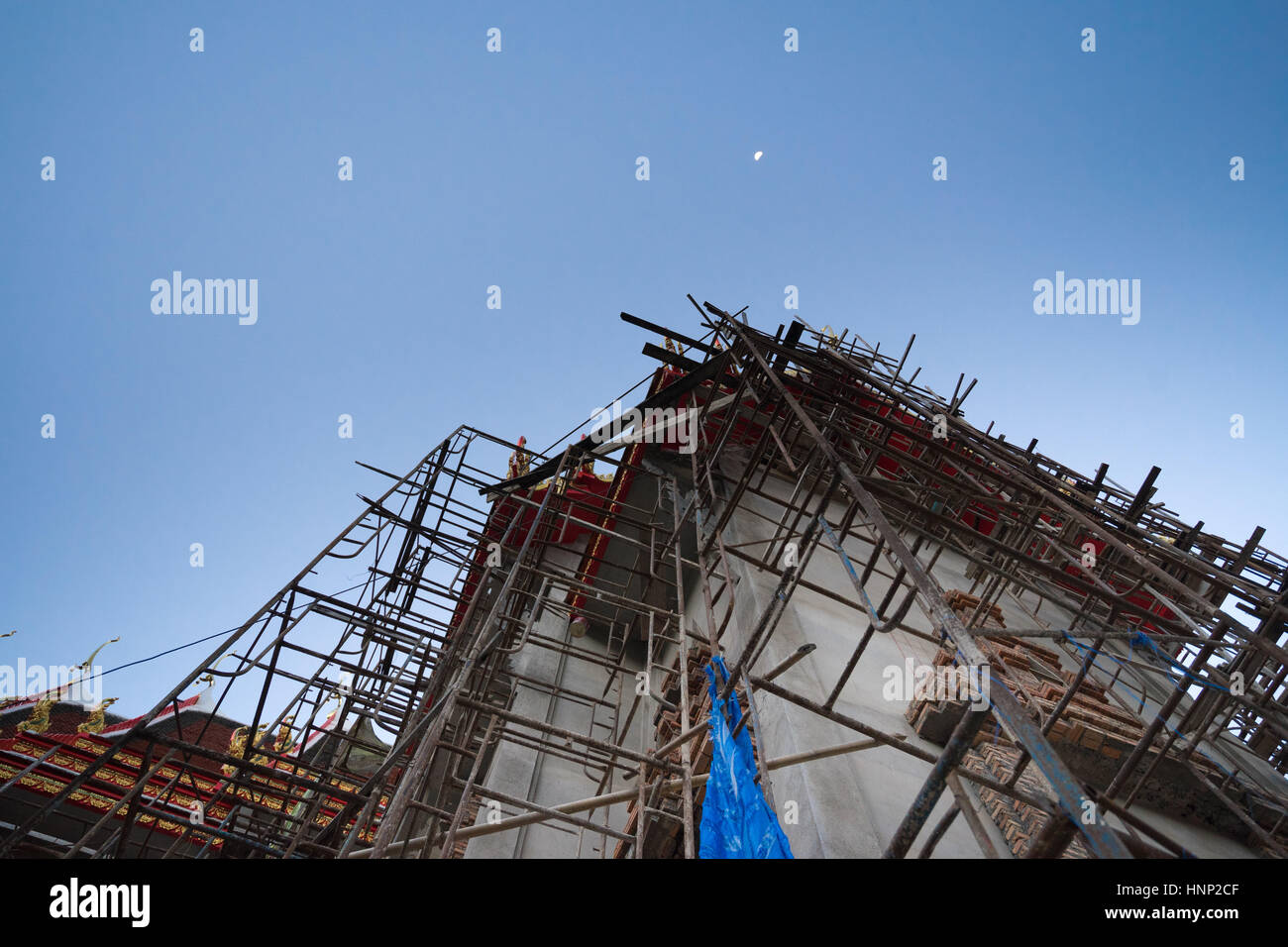 scaffolding for buddhism church construction with moon at evening at ...
