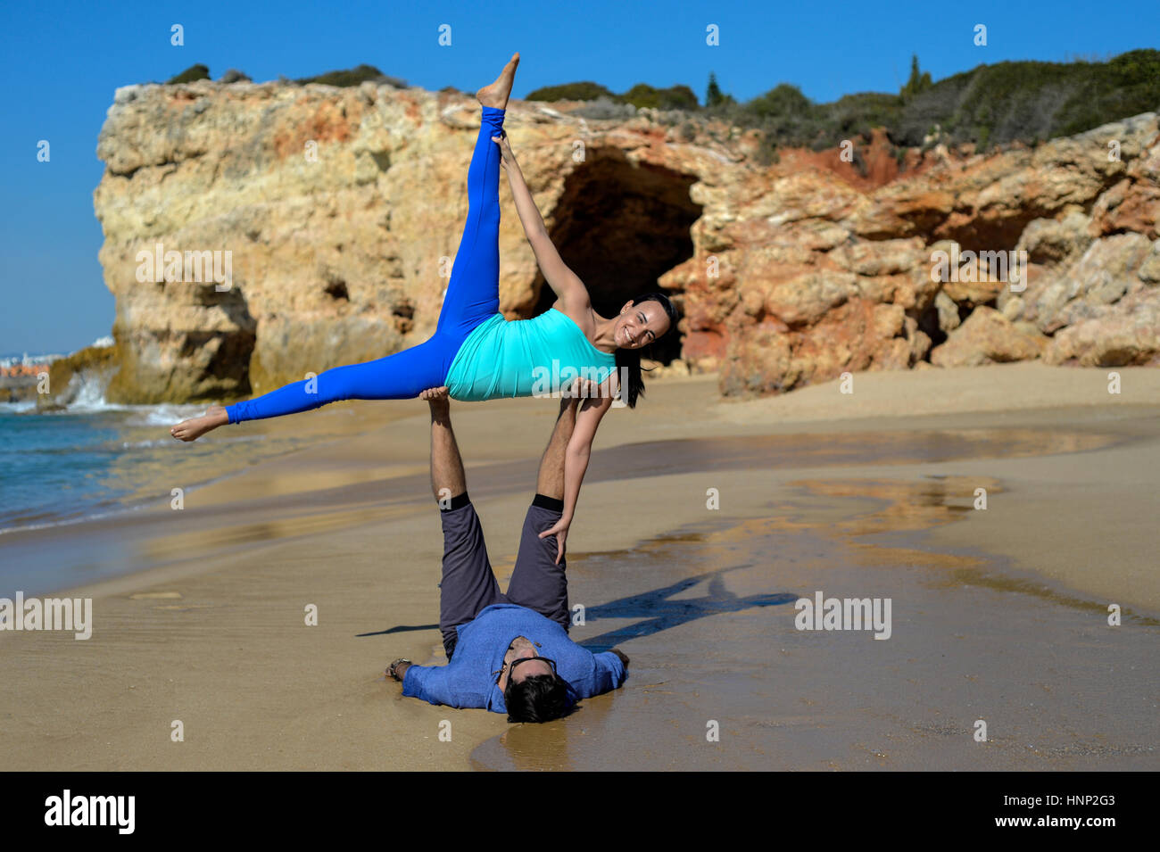 couple doing acro yoga Stock Photo - Alamy