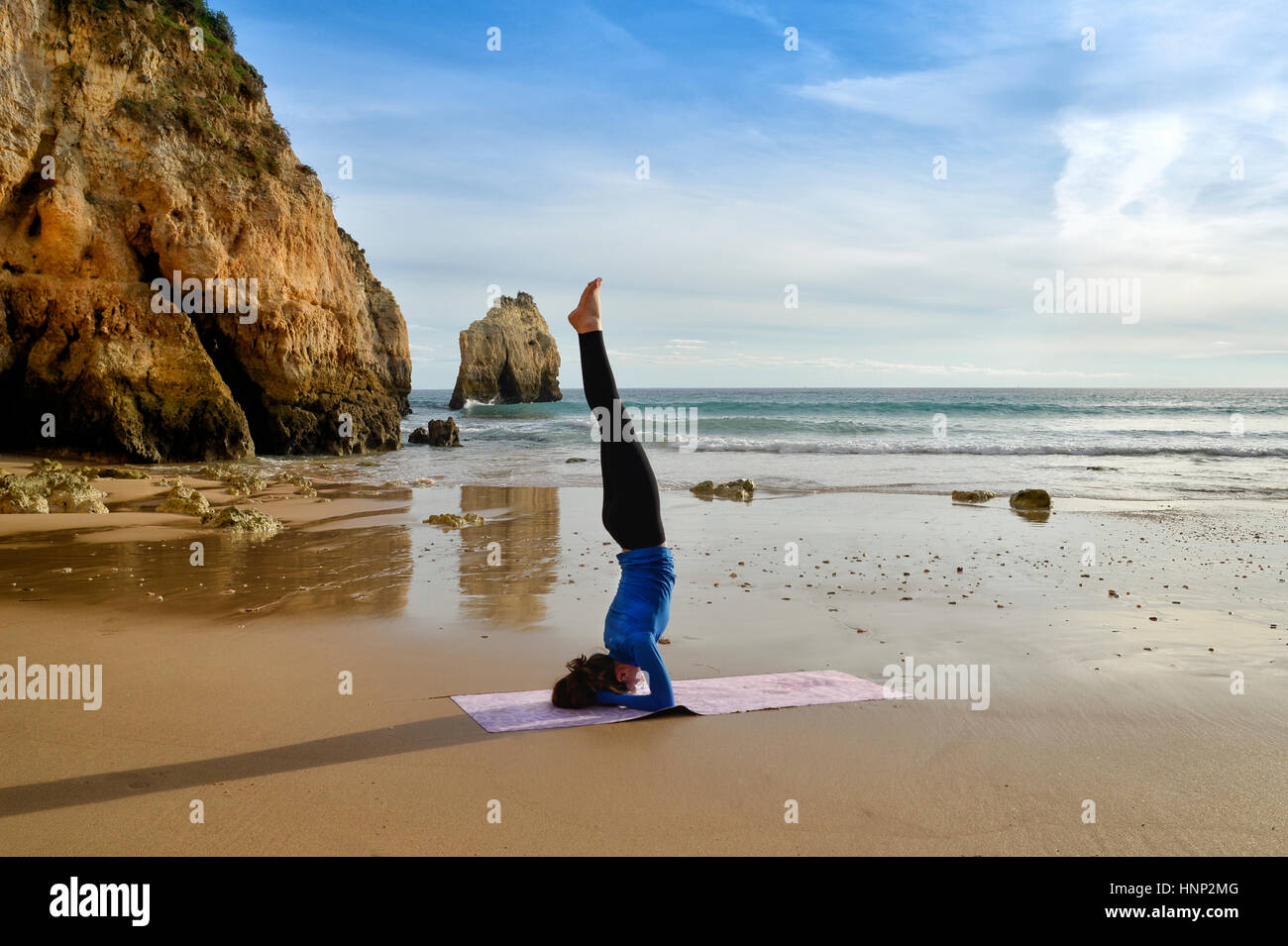 Woman doing headstand on beach hi-res stock photography and images - Alamy