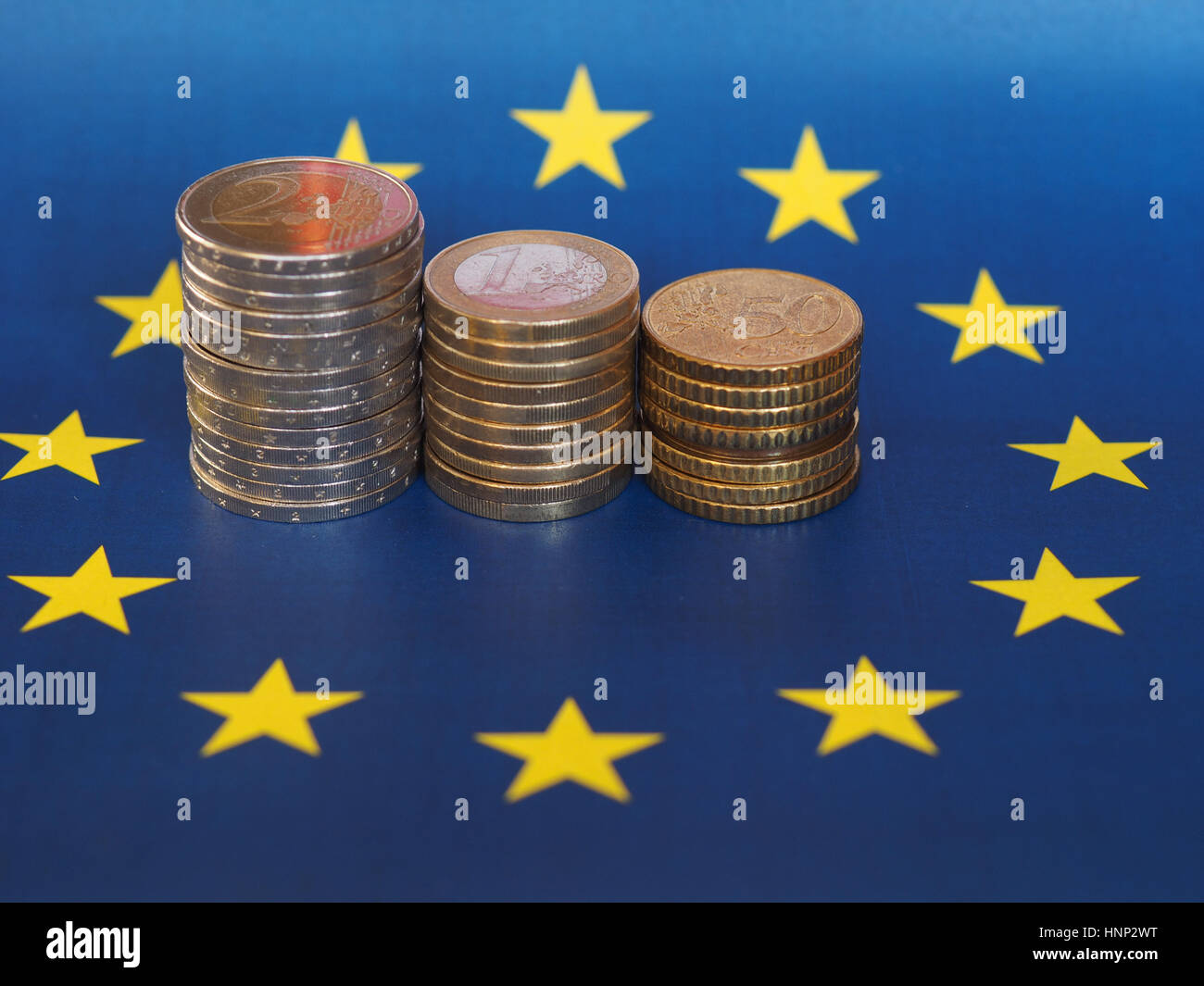Euro coins (EUR), currency of European Union over flag of Europe Stock ...