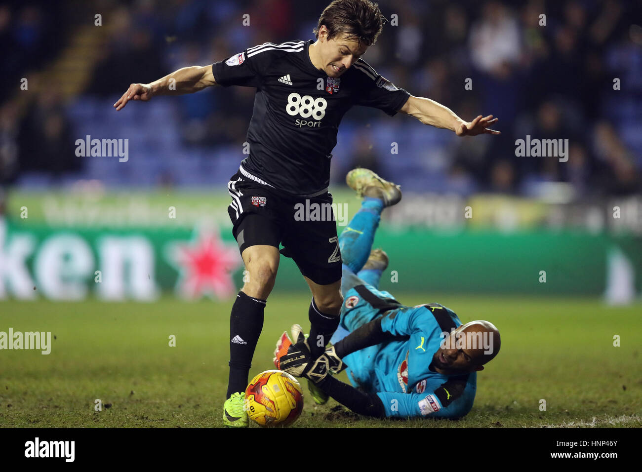 Reading goalkeeper Ali Al Habsi saves at the feet of Brentford's Lasse ...