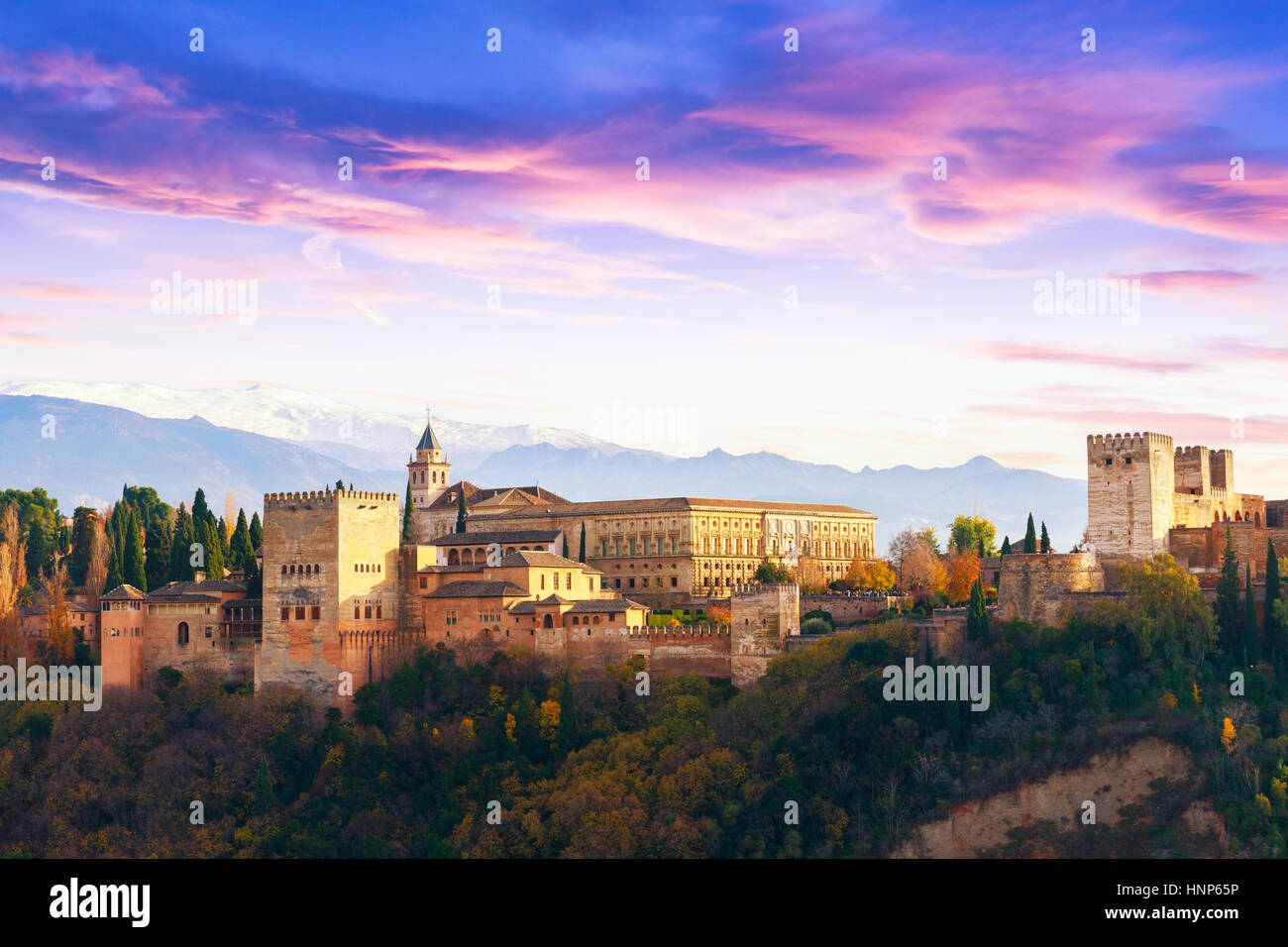 View of the famous Alhambra palacein Granada with Sierra Nevada ...